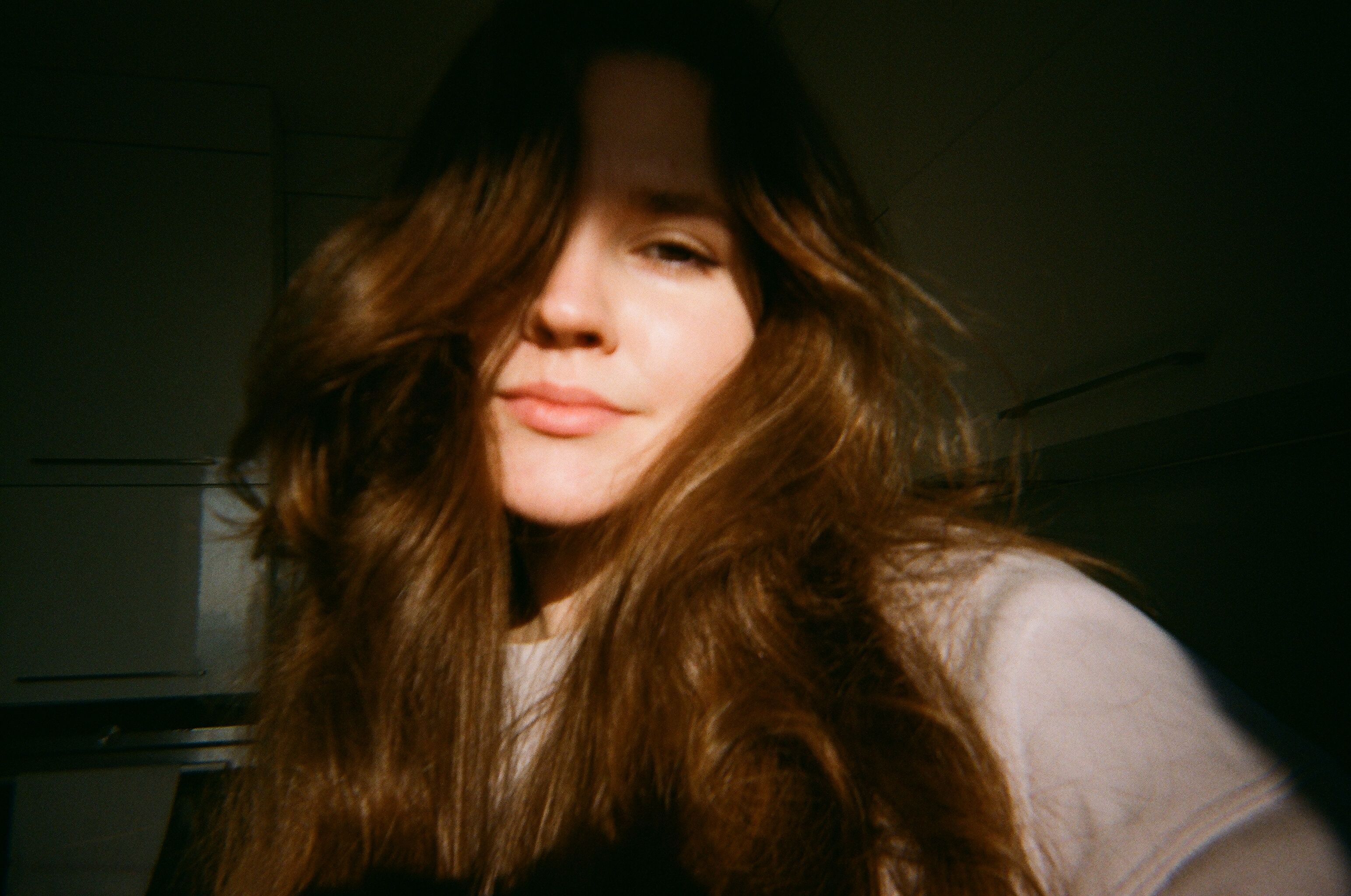 Warm Portrait of a Young Woman with Long Hair · Free Stock Photo