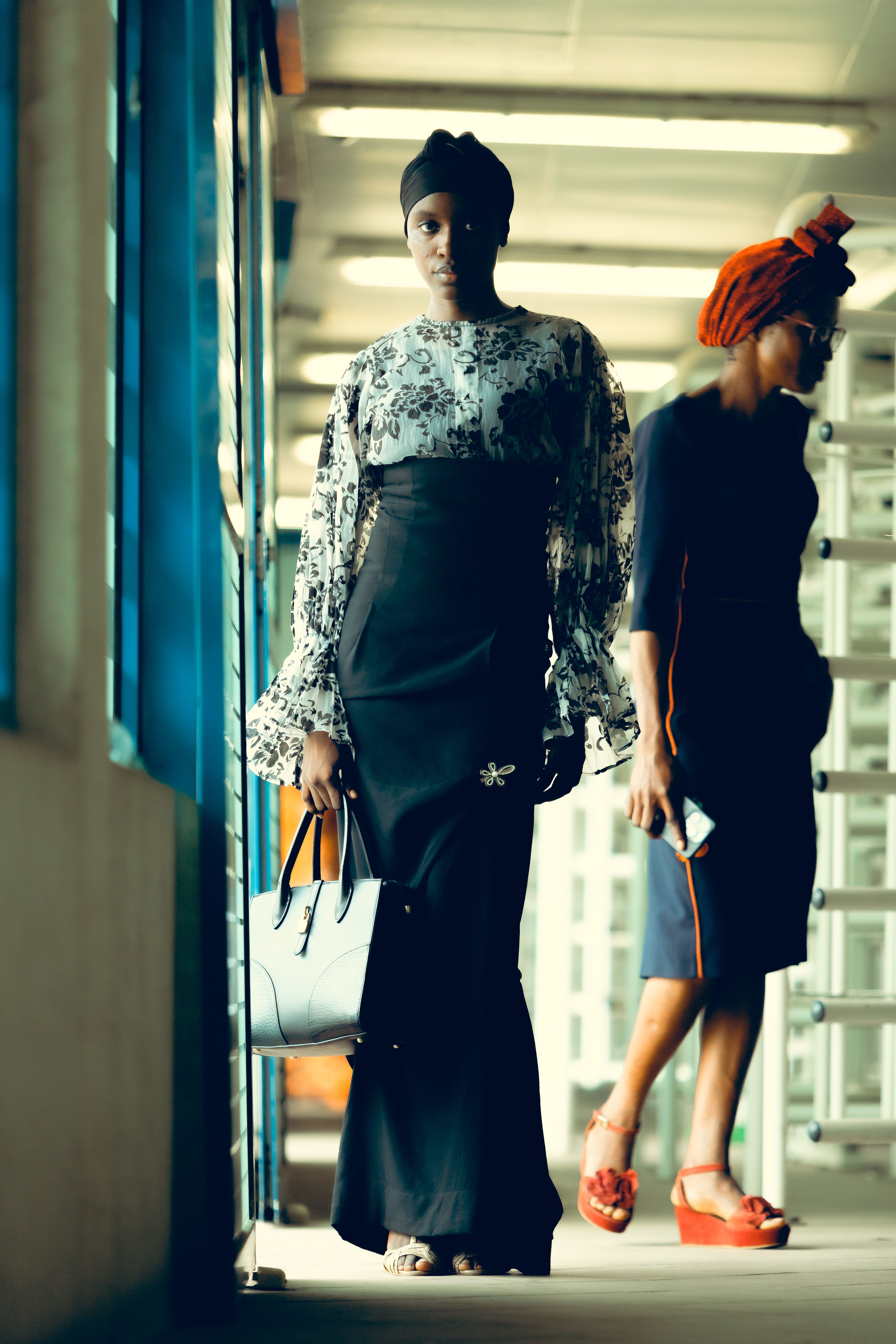 Fashionable women walking in modern hallway · Free Stock Photo