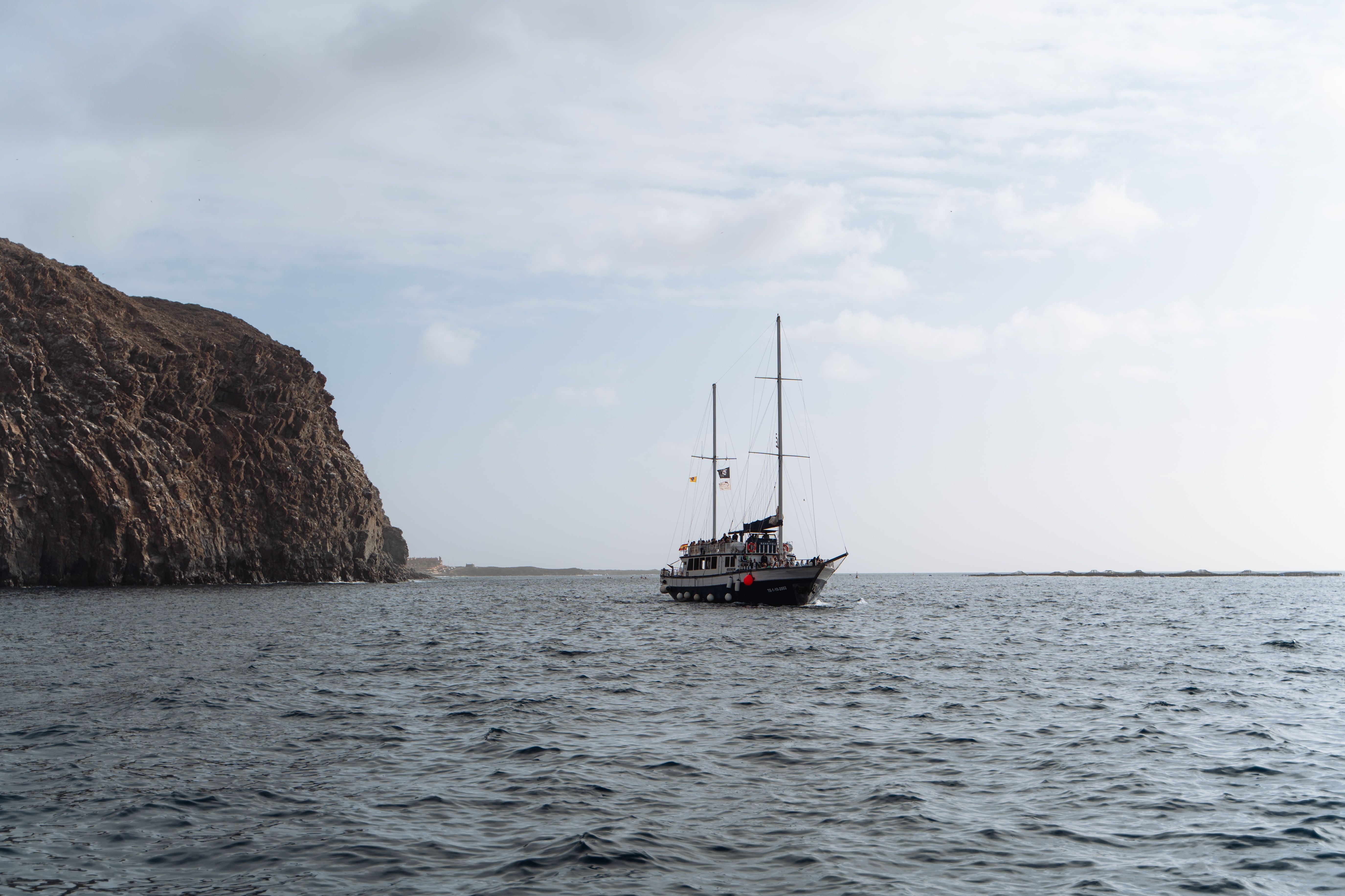 Sailing Ship by Rocky Cliffs in Tenerife Waters · Free Stock Photo