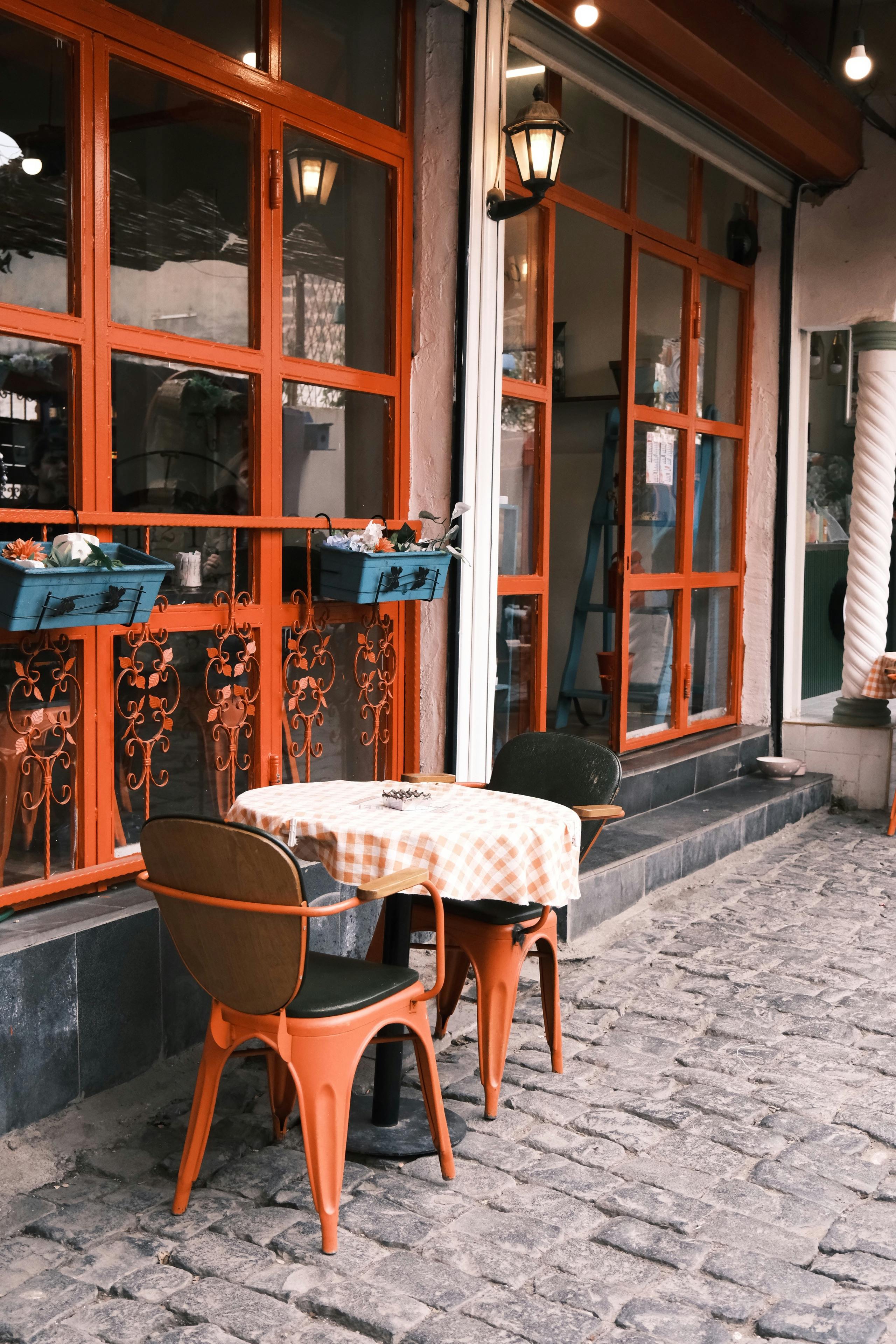 Charming Outdoor Cafe with Brick Pathway · Free Stock Photo