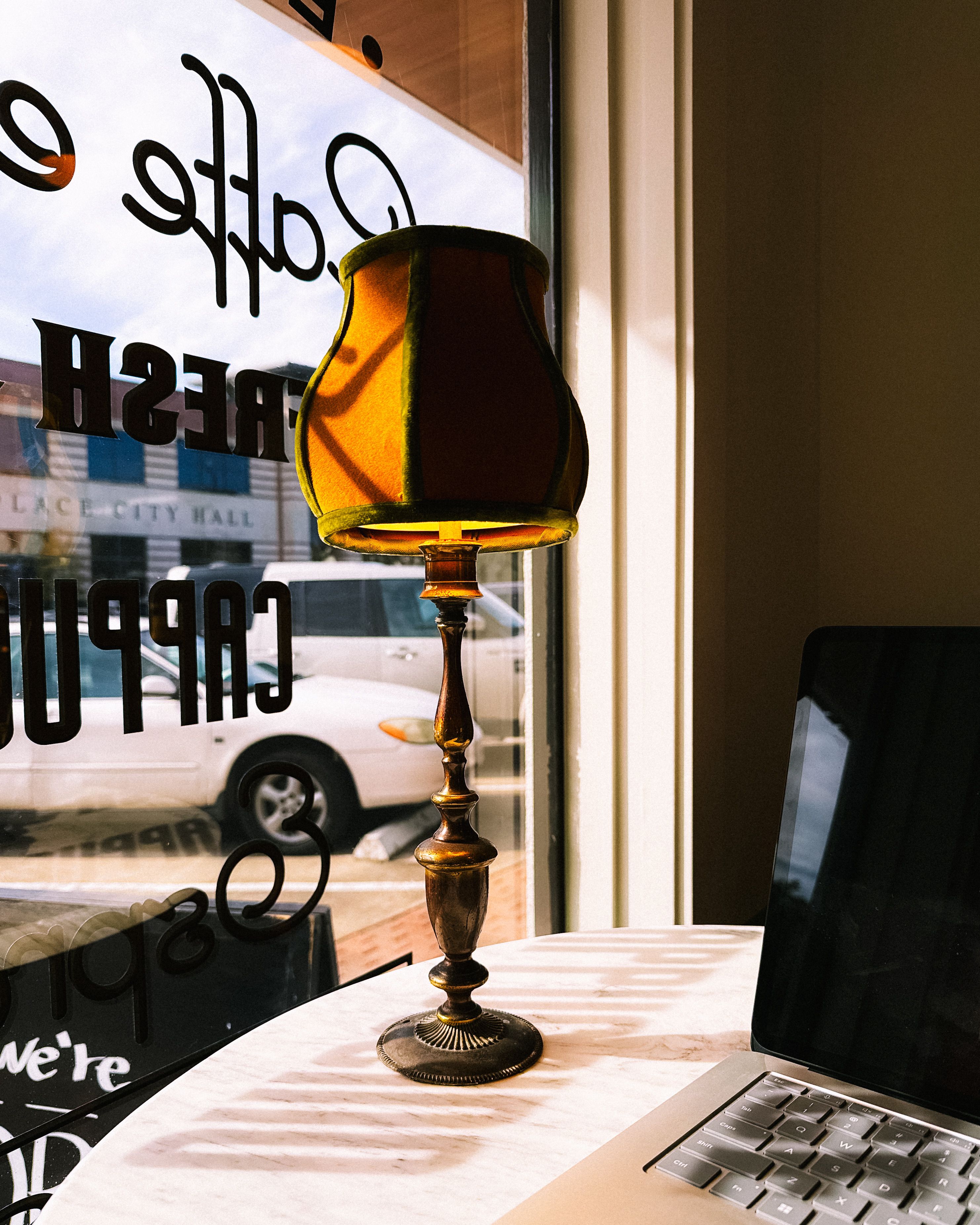 Cozy Coffee Shop Setting with Antique Lamp · Free Stock Photo