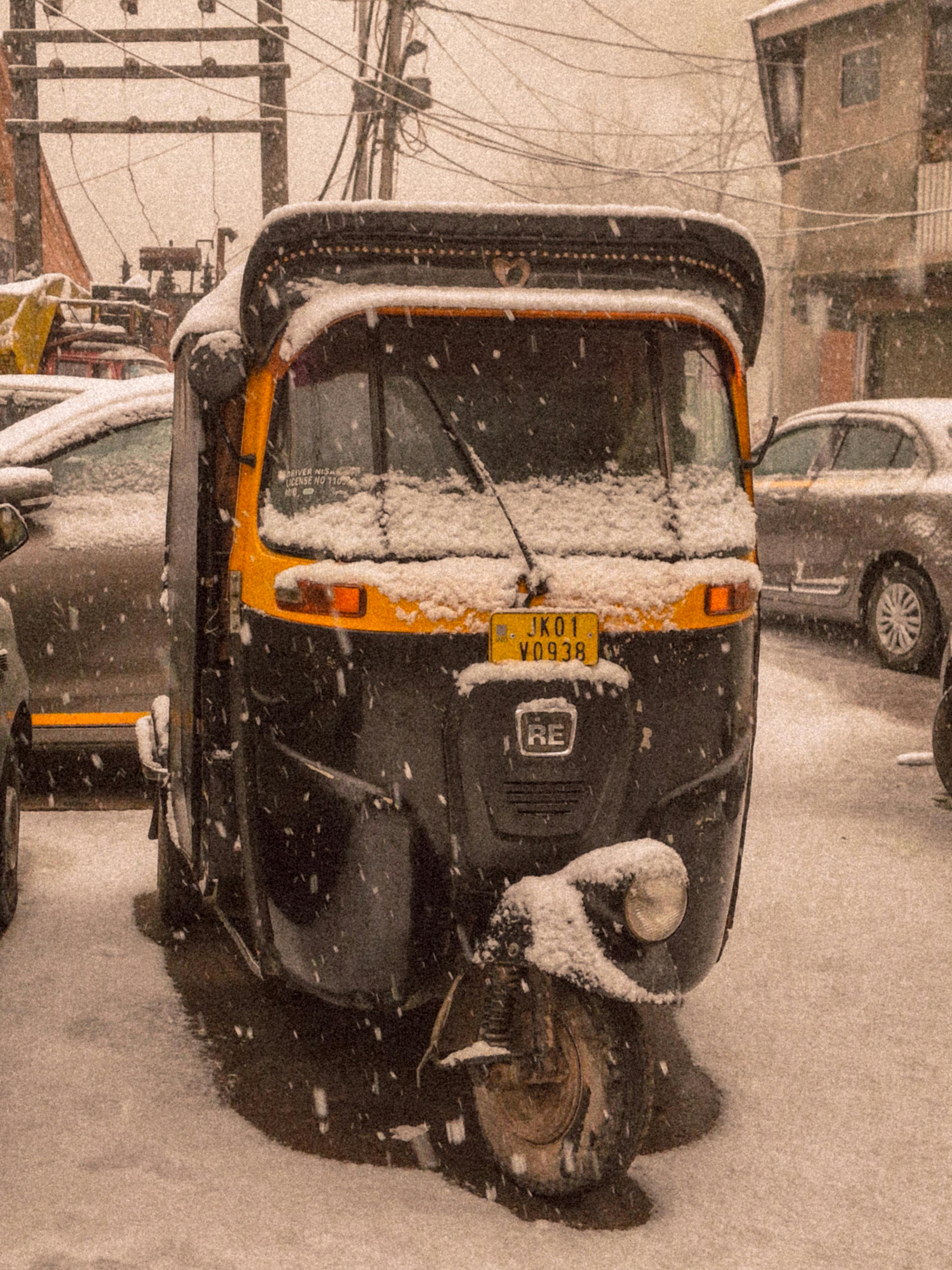 Snow-covered Auto Rickshaw in Urban Street · Free Stock Photo