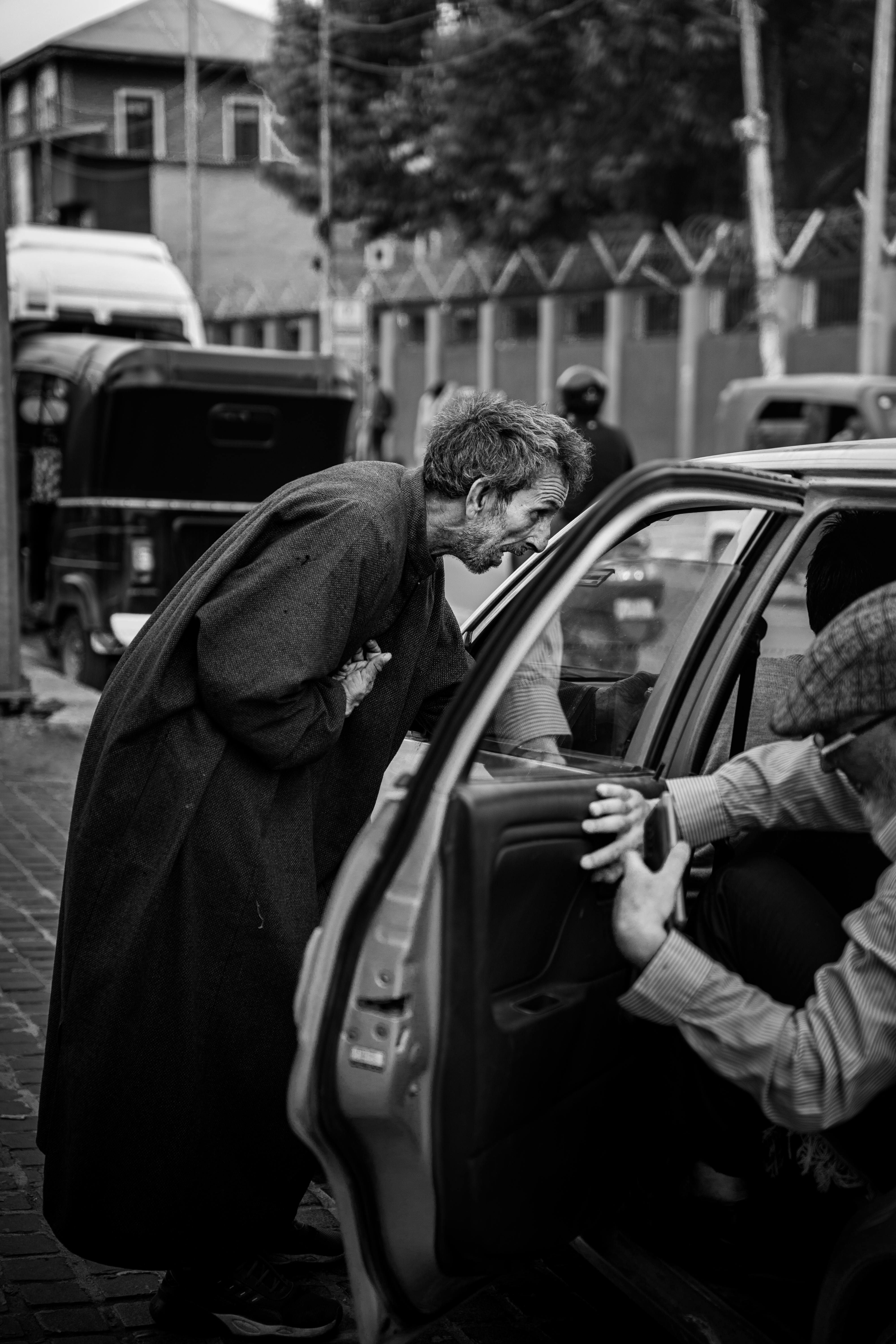 Touching Street Interaction Captured in Black and White · Free Stock Photo
