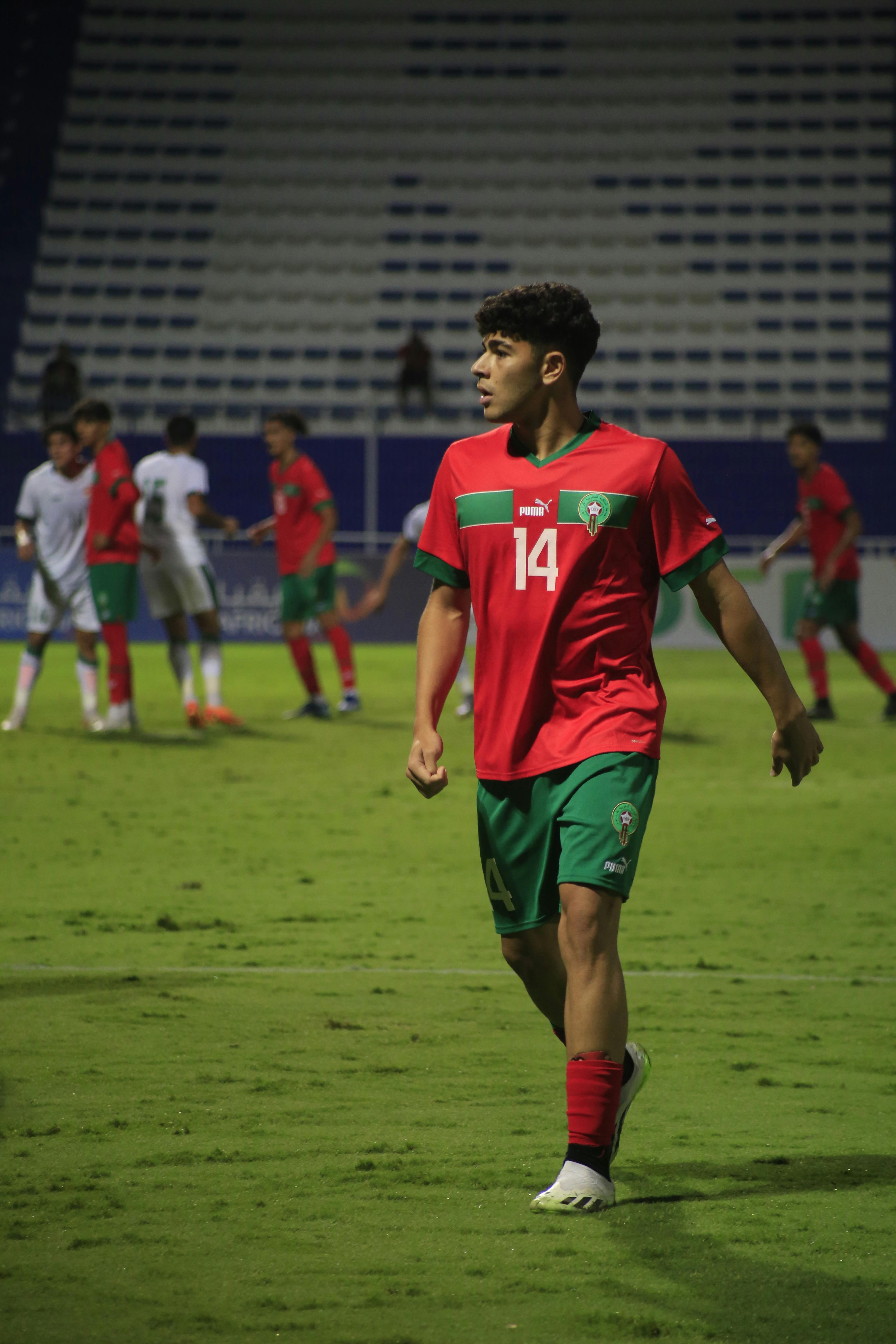 Moroccan Soccer Player on the Field at Night · Free Stock Photo