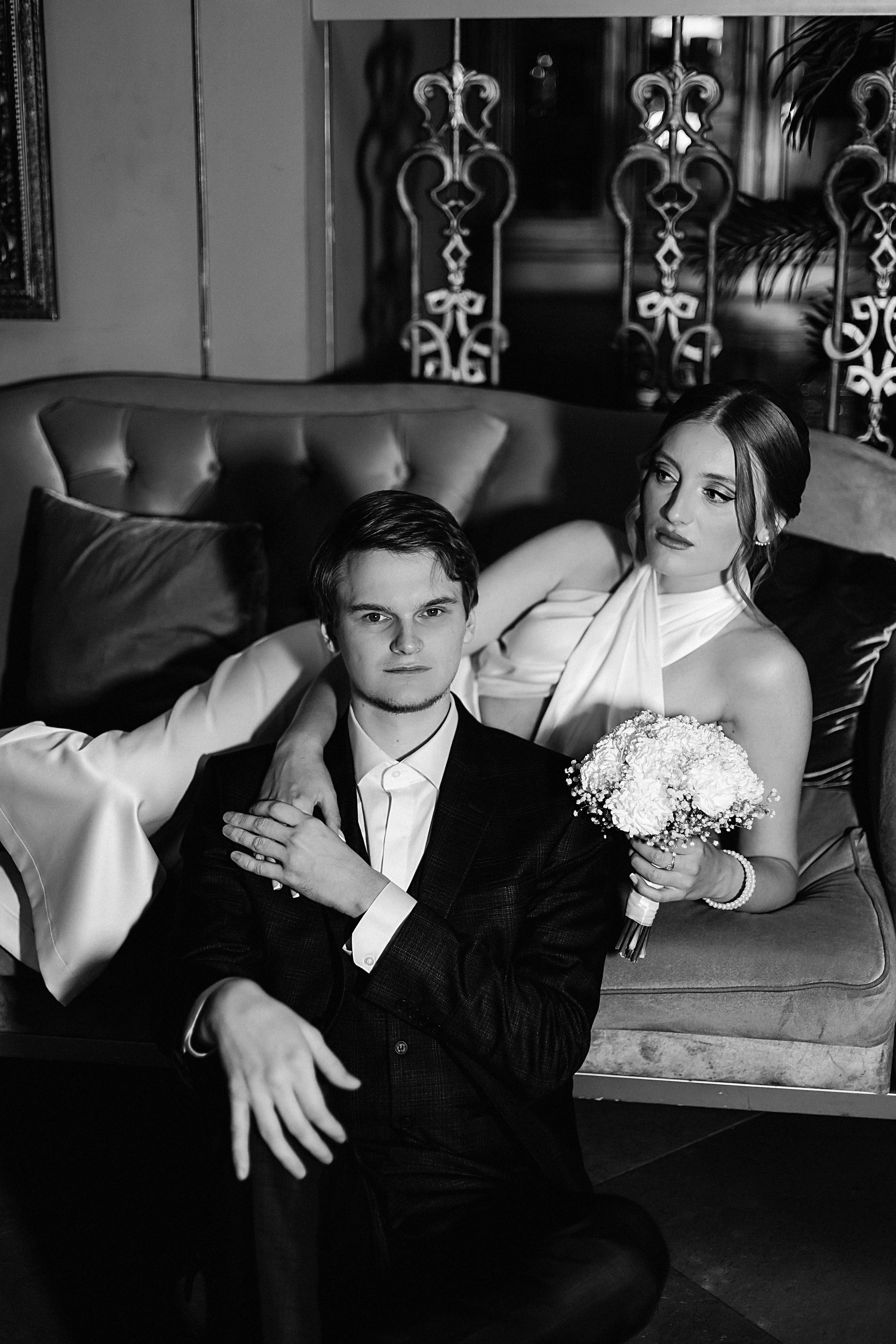 Elegant Couple in Formal Attire on Sofa · Free Stock Photo