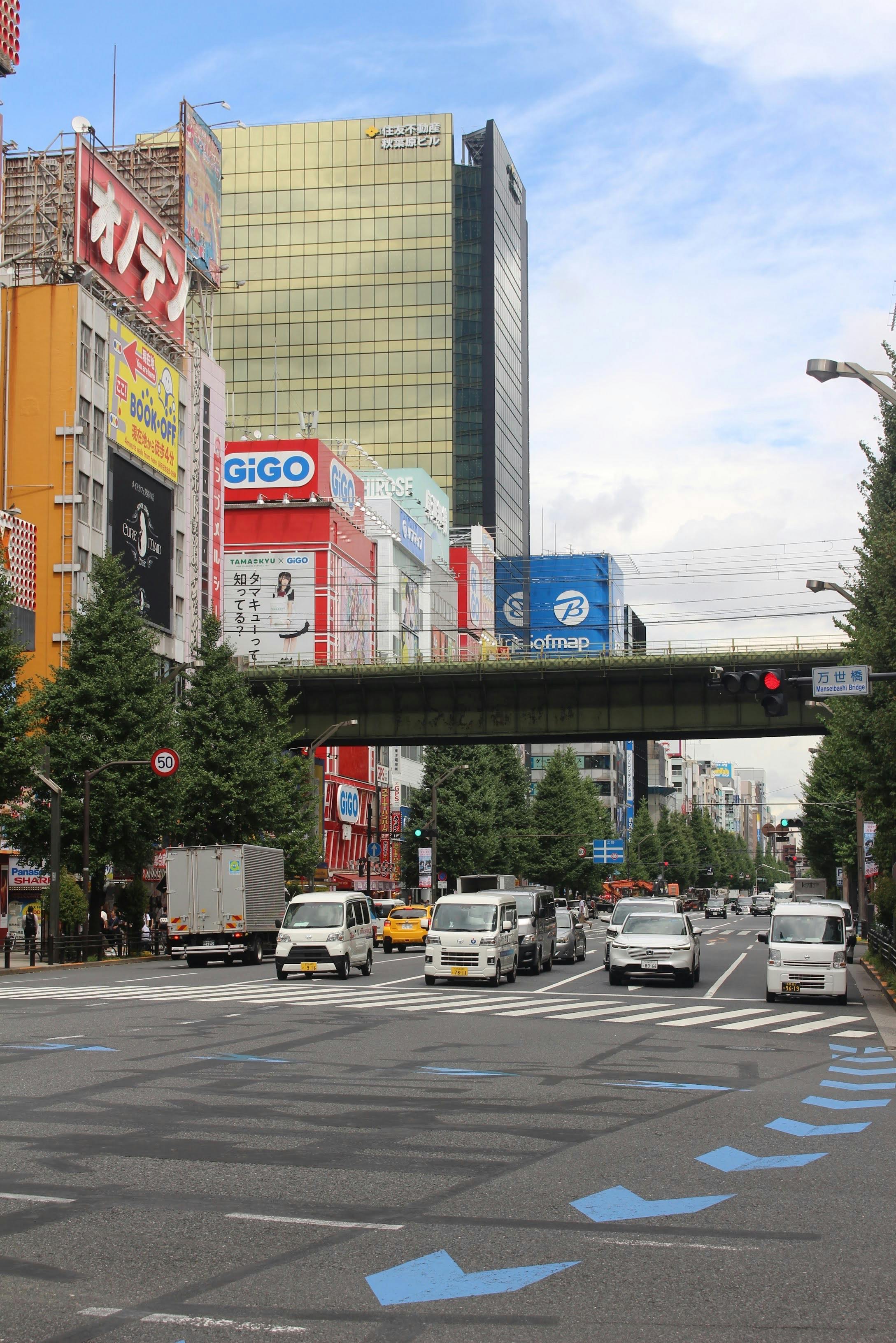 Bustling Tokyo Street with Traffic and Skyscrapers · Free Stock Photo