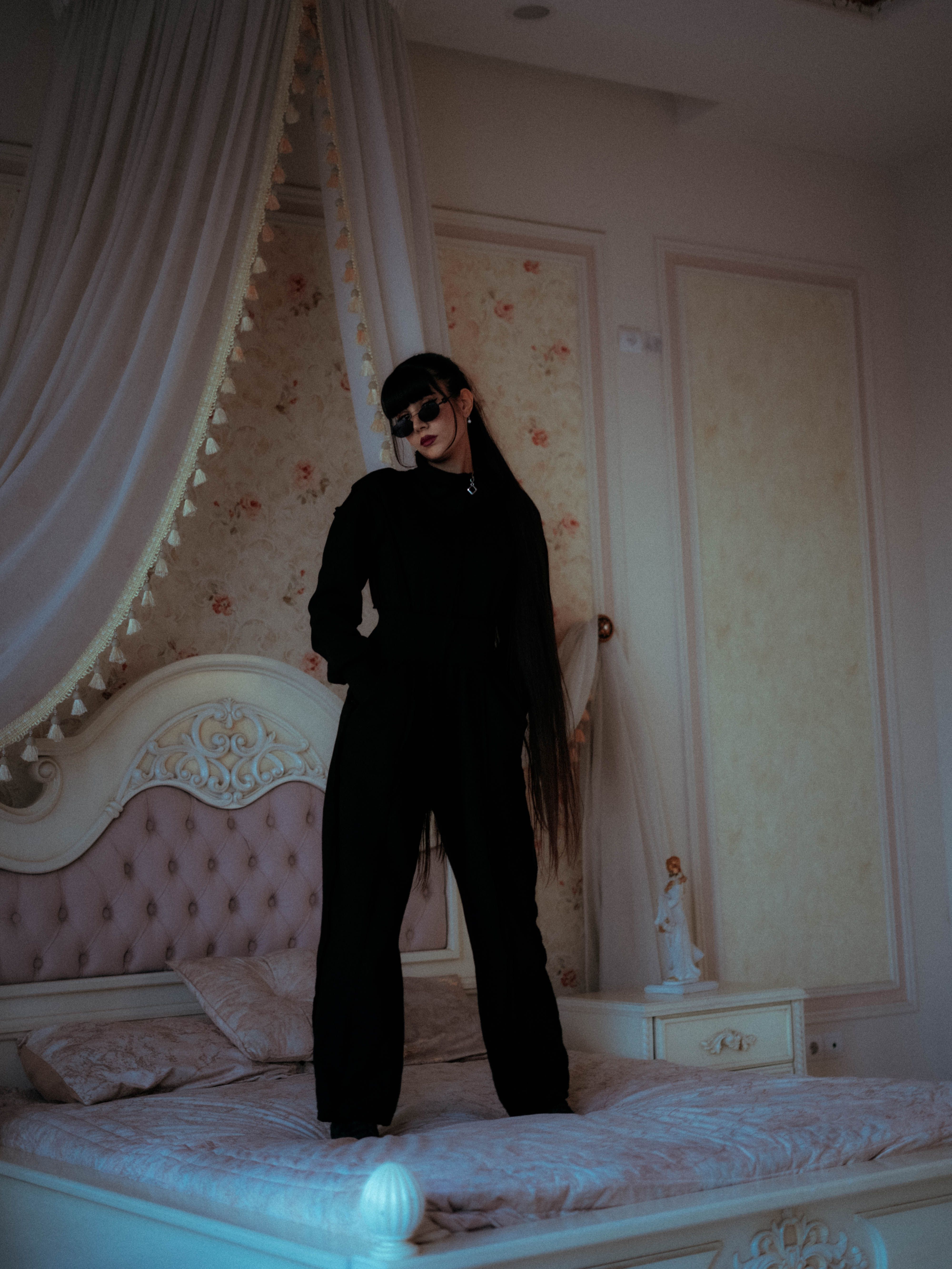 Woman in Gothic Outfit Standing in Stylish Bedroom · Free Stock Photo