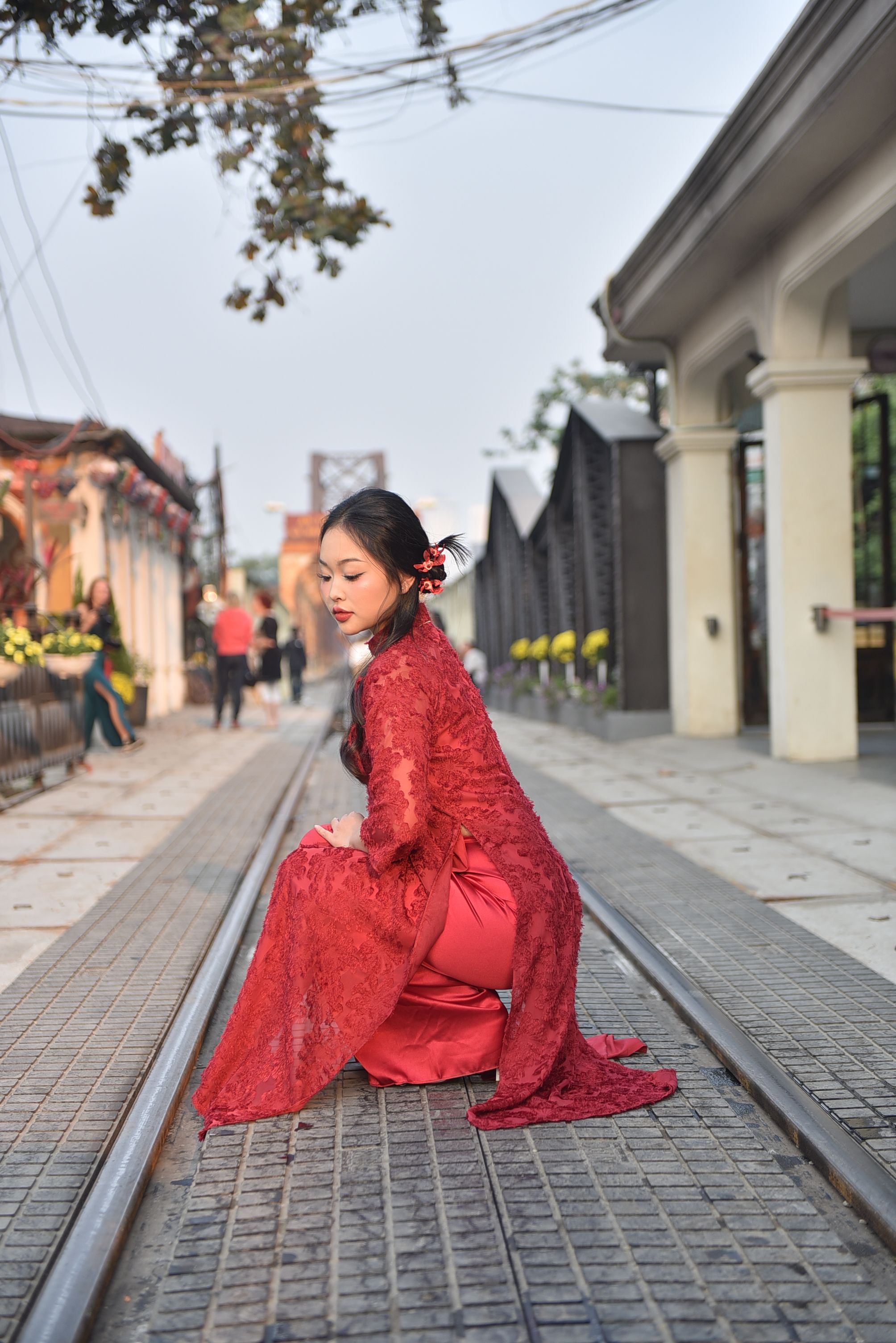 Elegant Woman in Red Traditional Dress on Train Tracks · Free Stock Photo