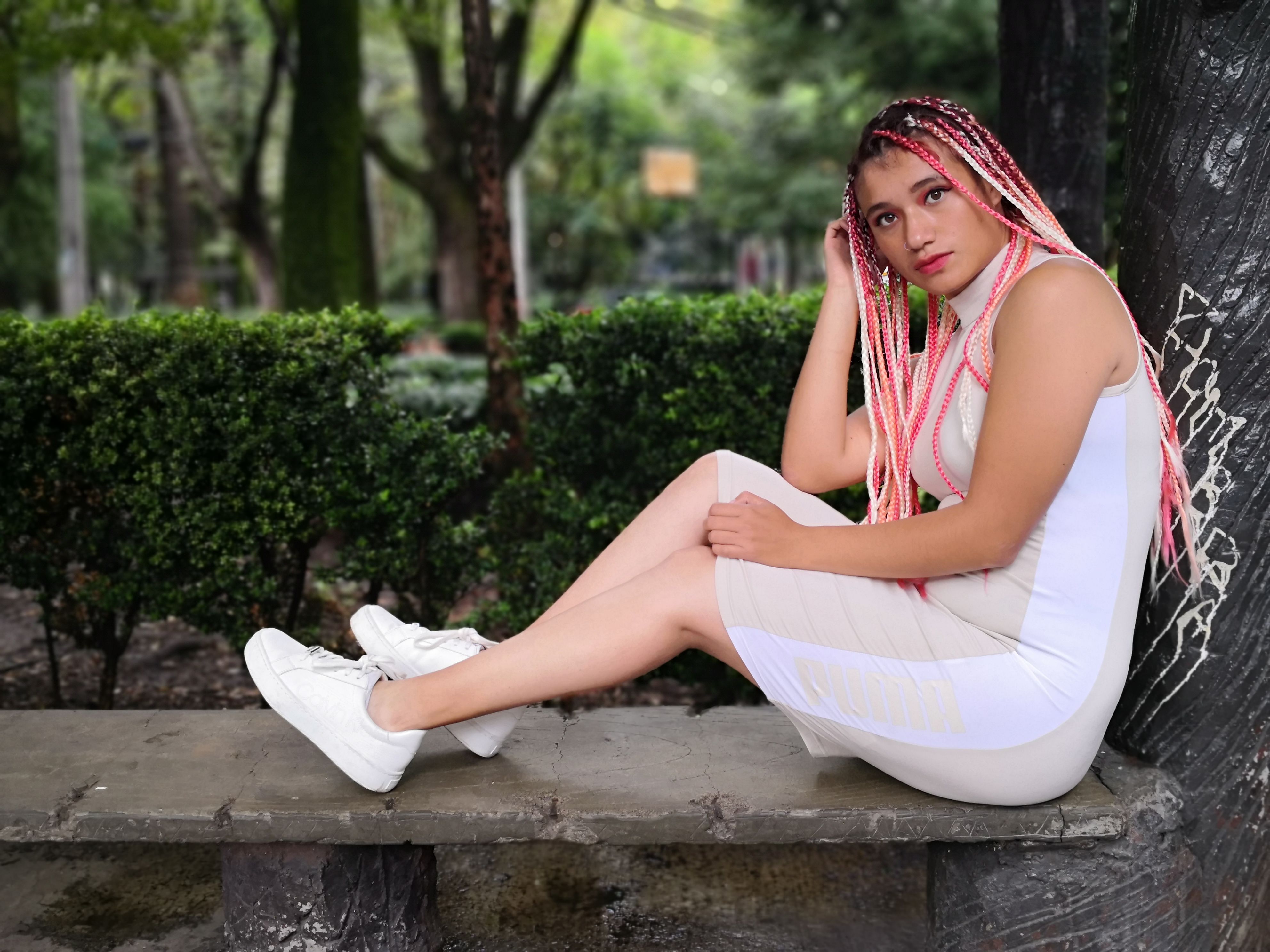 Stylish Woman with Braided Hair in Urban Park Setting · Free Stock Photo