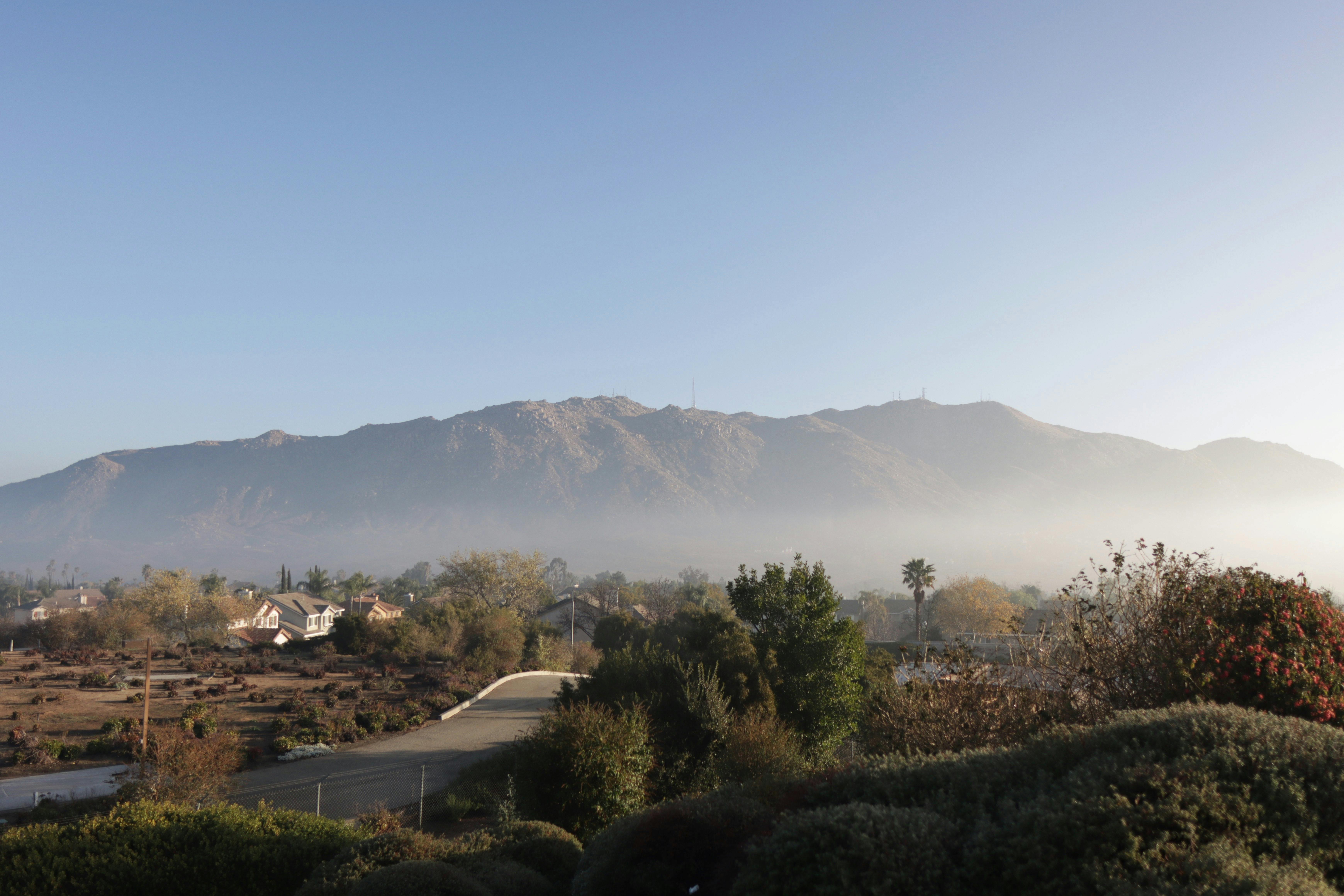 Scenic View of Misty Mountains in Riverside · Free Stock Photo