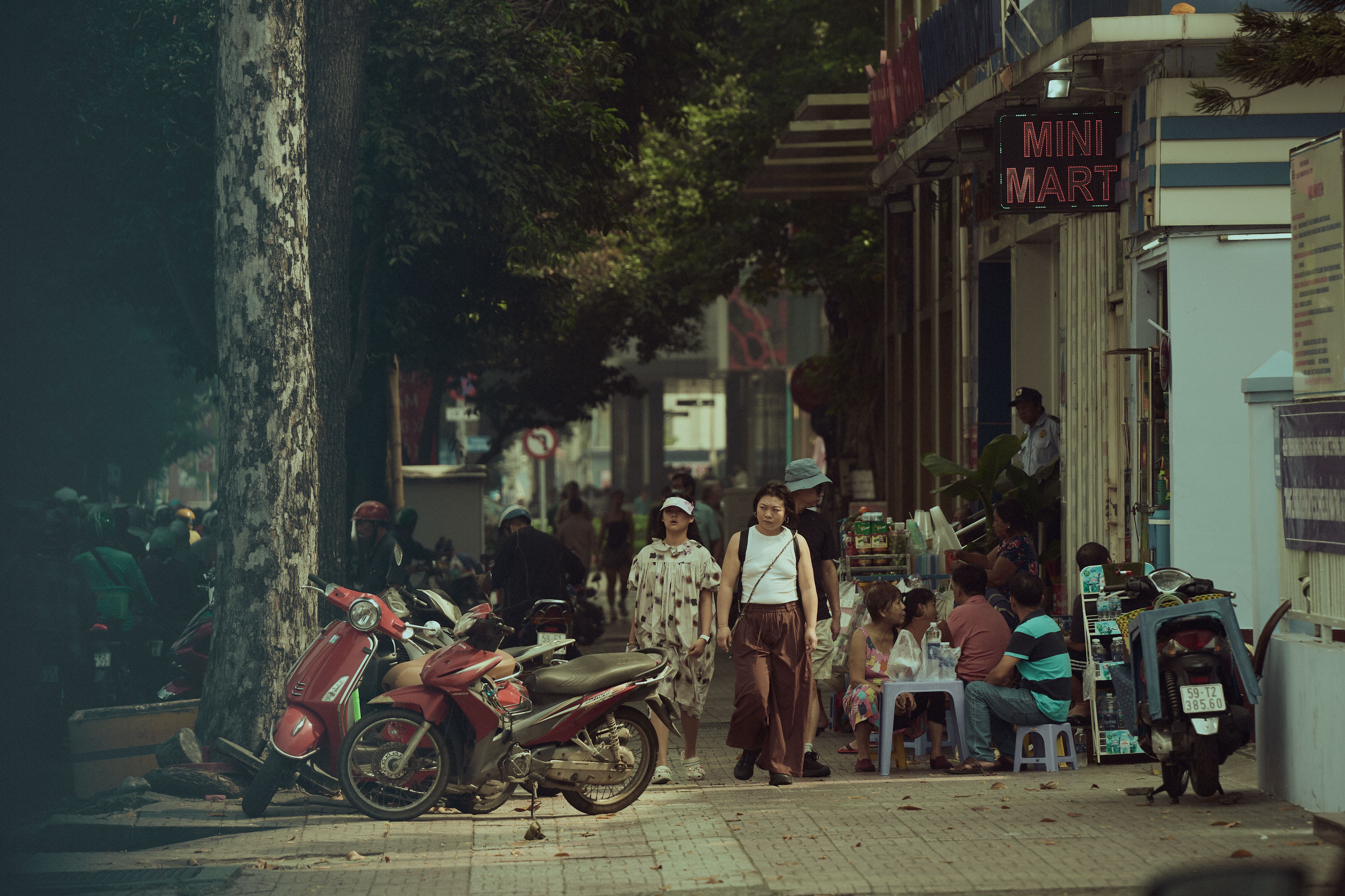 Street Scene with Motorbikes and Mini Mart · Free Stock Photo