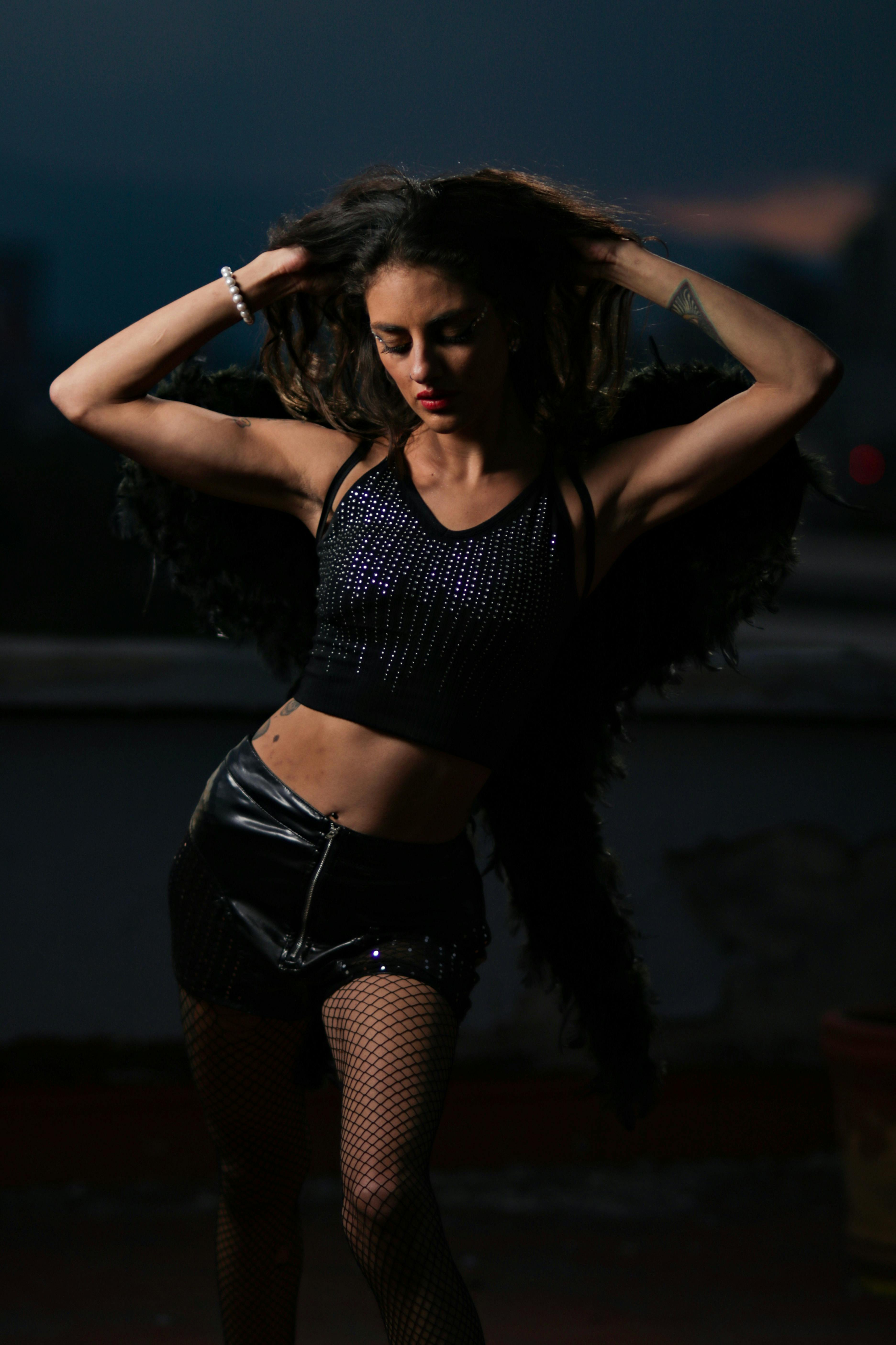 Elegant Dancer Posing in Dramatic Lighting · Free Stock Photo