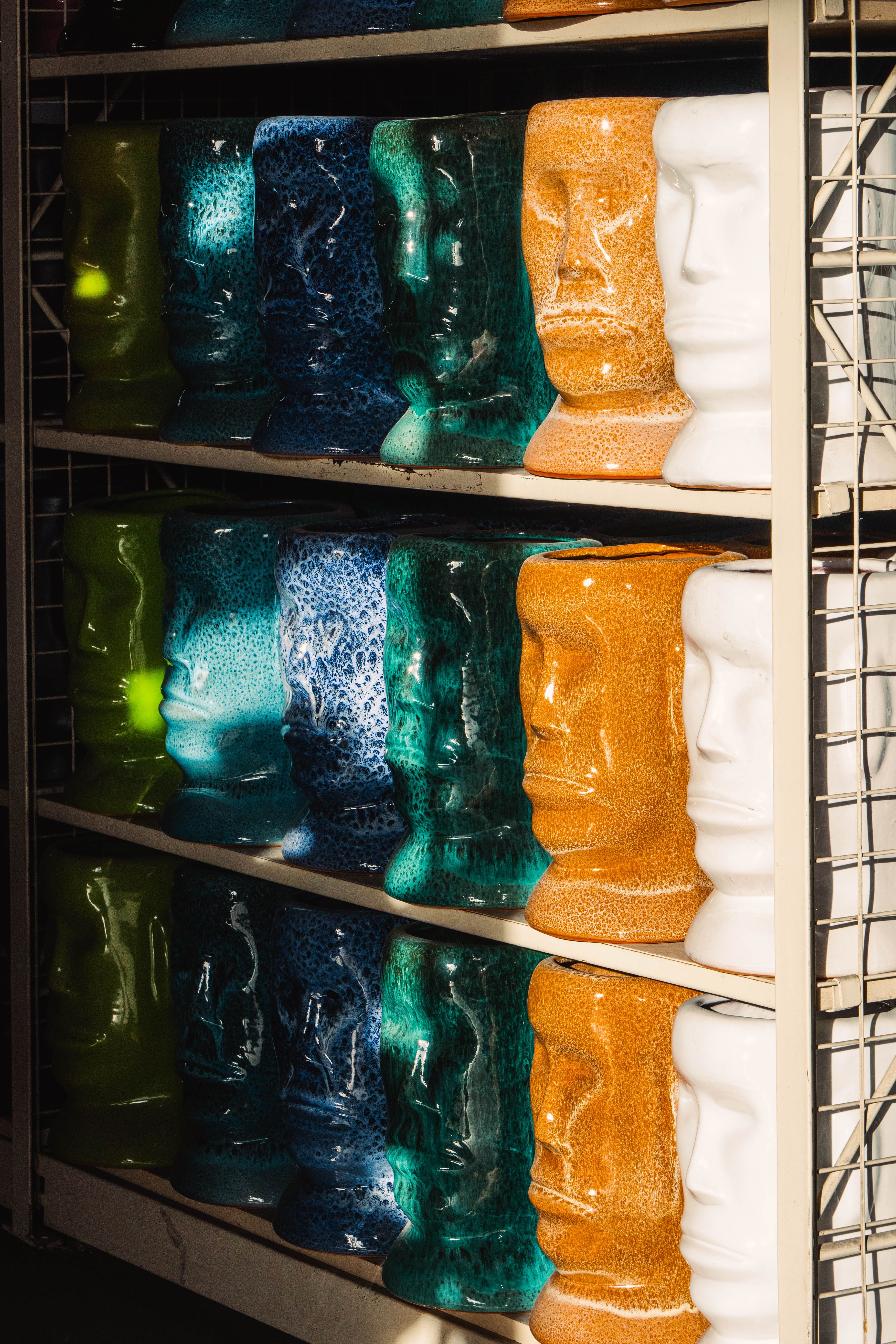 Colorful Ceramic Heads on Display Shelf · Free Stock Photo