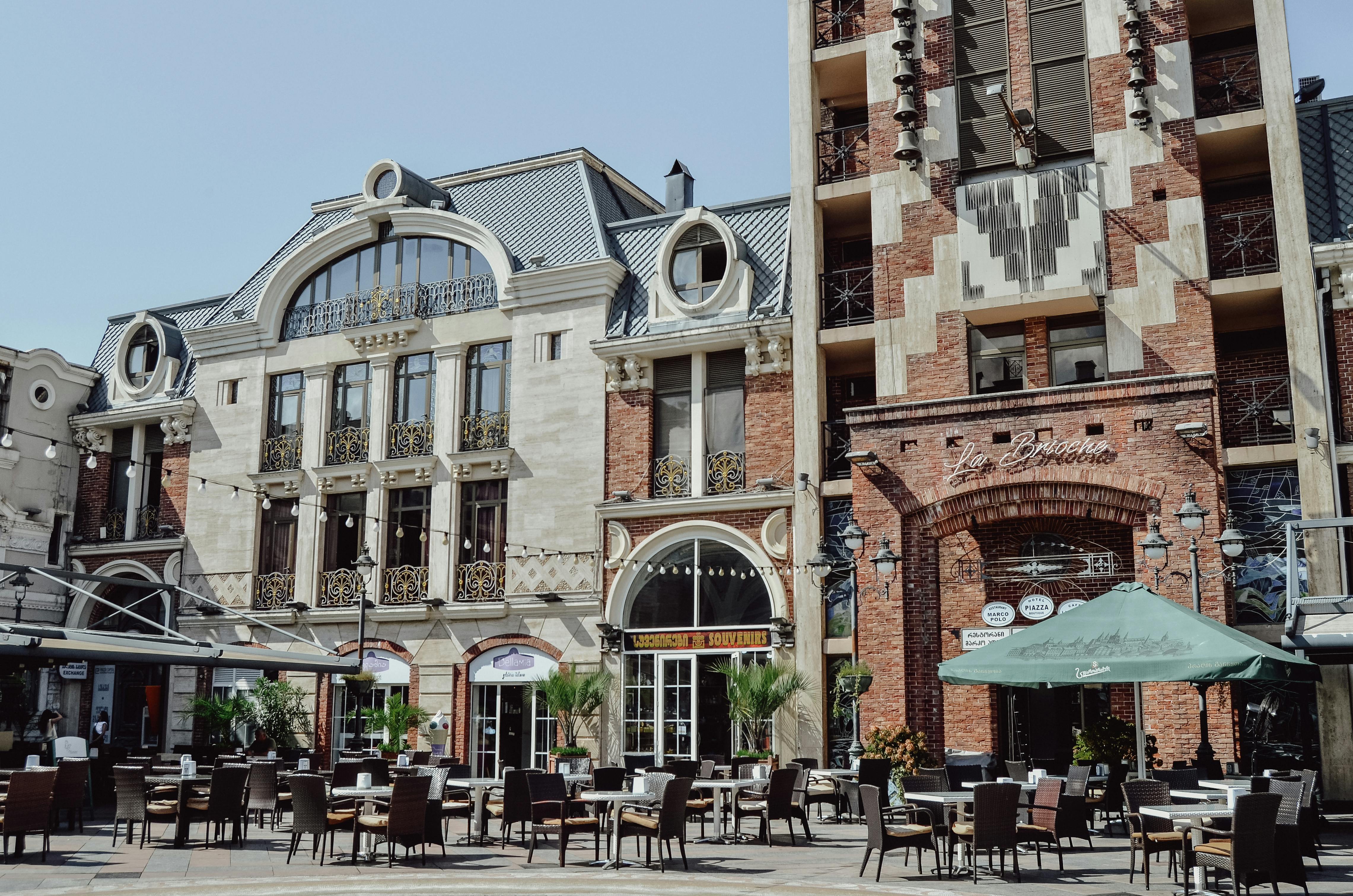 Charming European Outdoor Cafe Under Clear Sky · Free Stock Photo