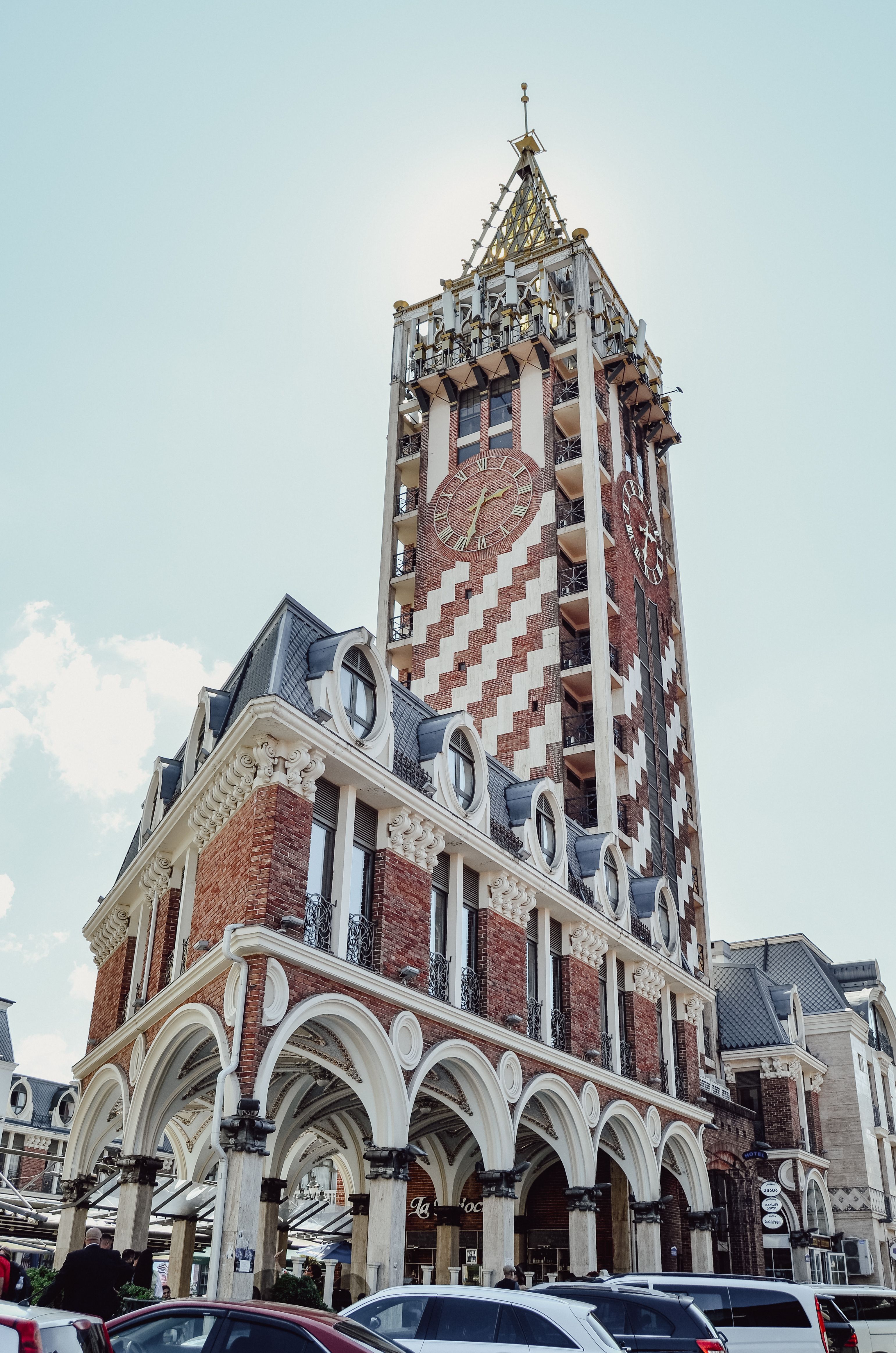 Architectural Clock Tower with Arched Facade · Free Stock Photo