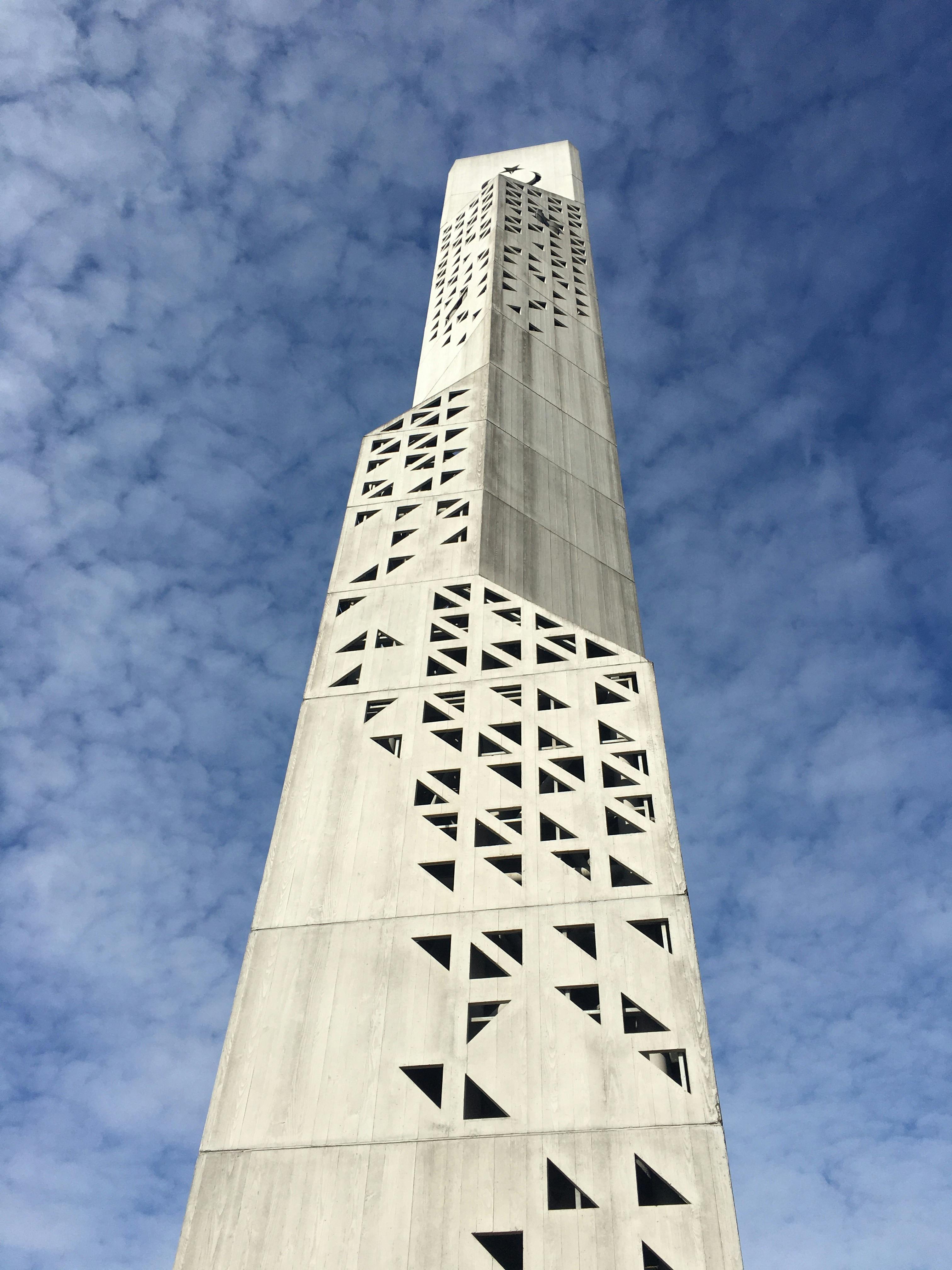 Unique Modern Architectural Tower Against Cloudy Sky · Free Stock Photo