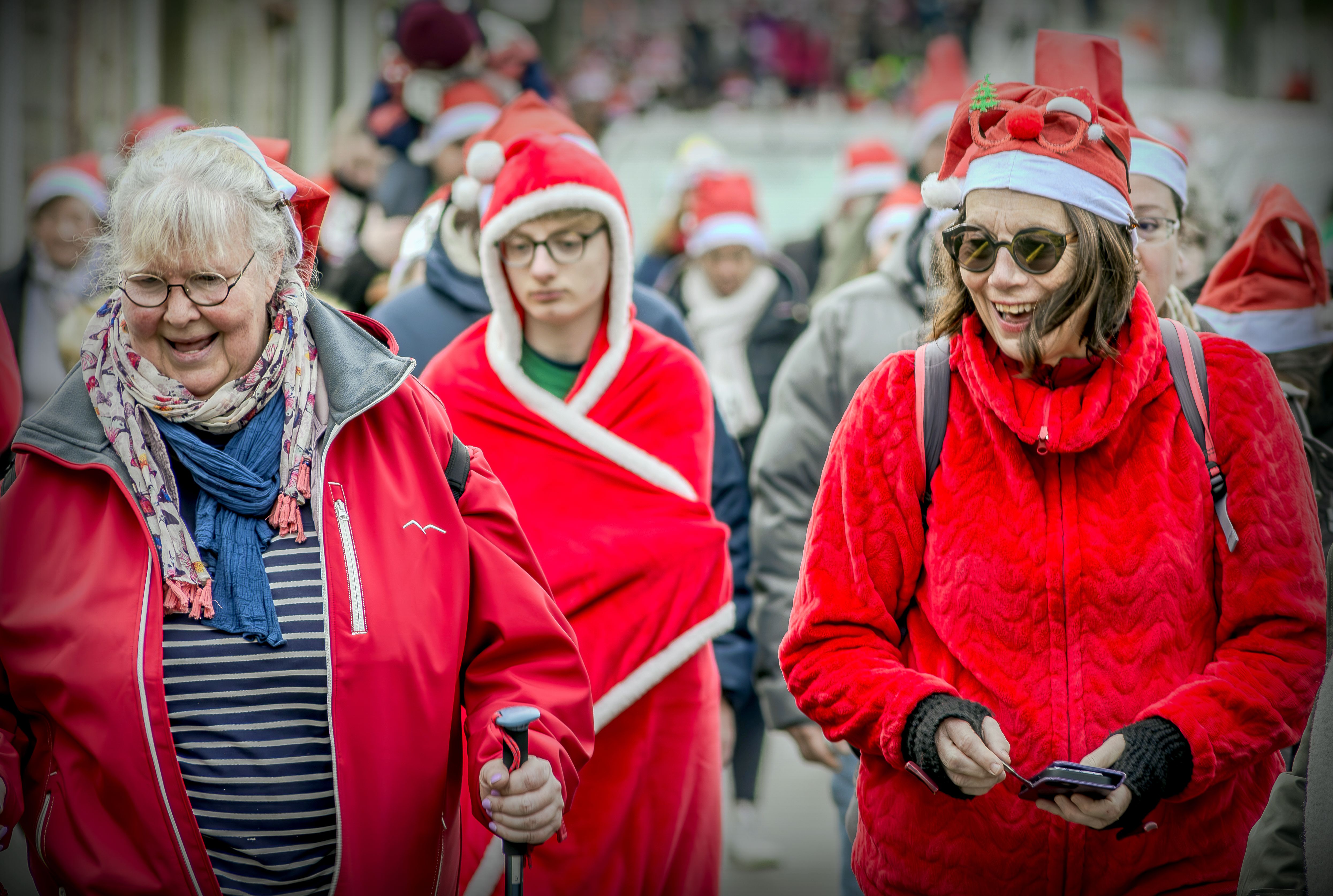 Festive Santa Walk with Smiling Participants · Free Stock Photo