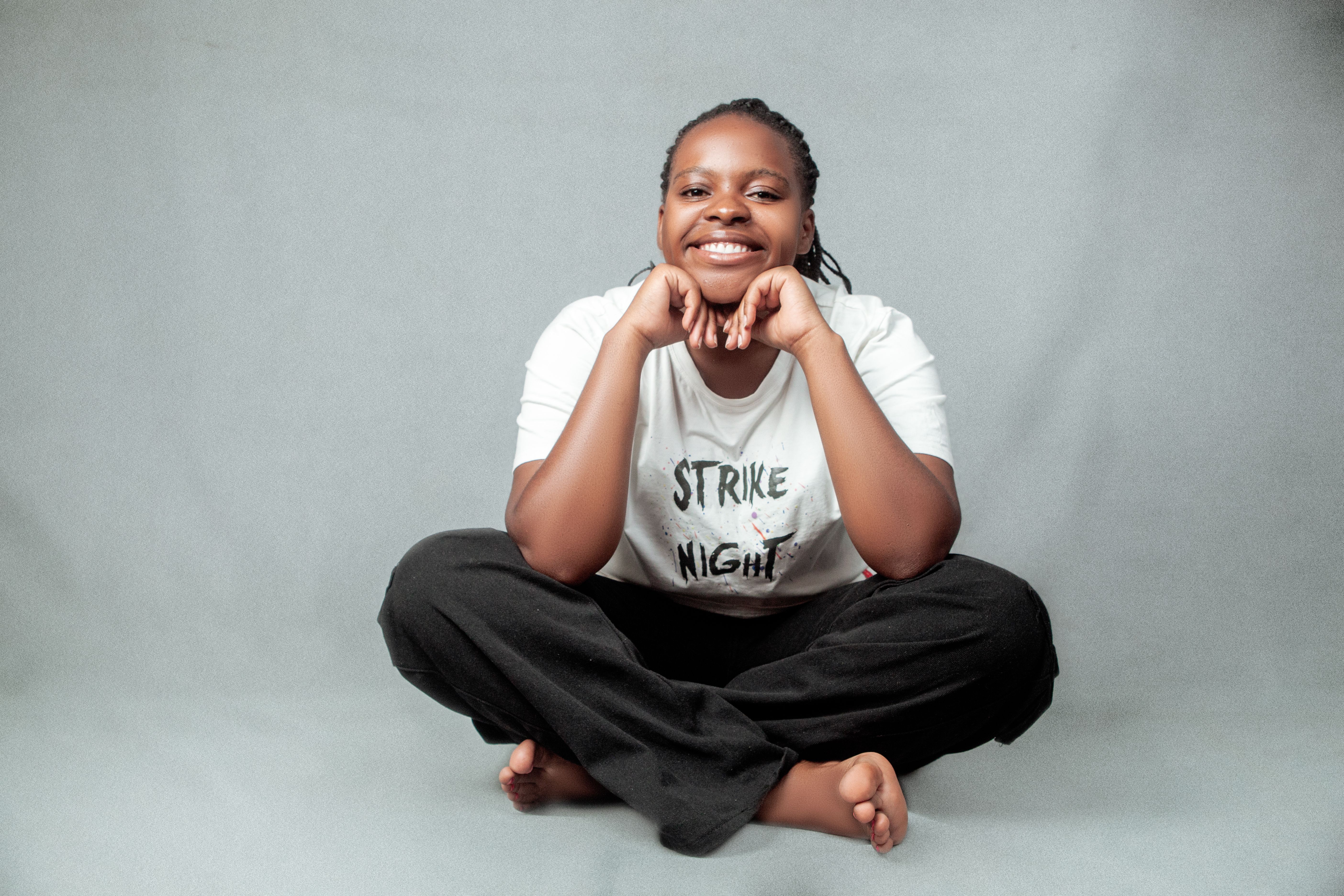 Smiling African Woman Sitting in Studio · Free Stock Photo