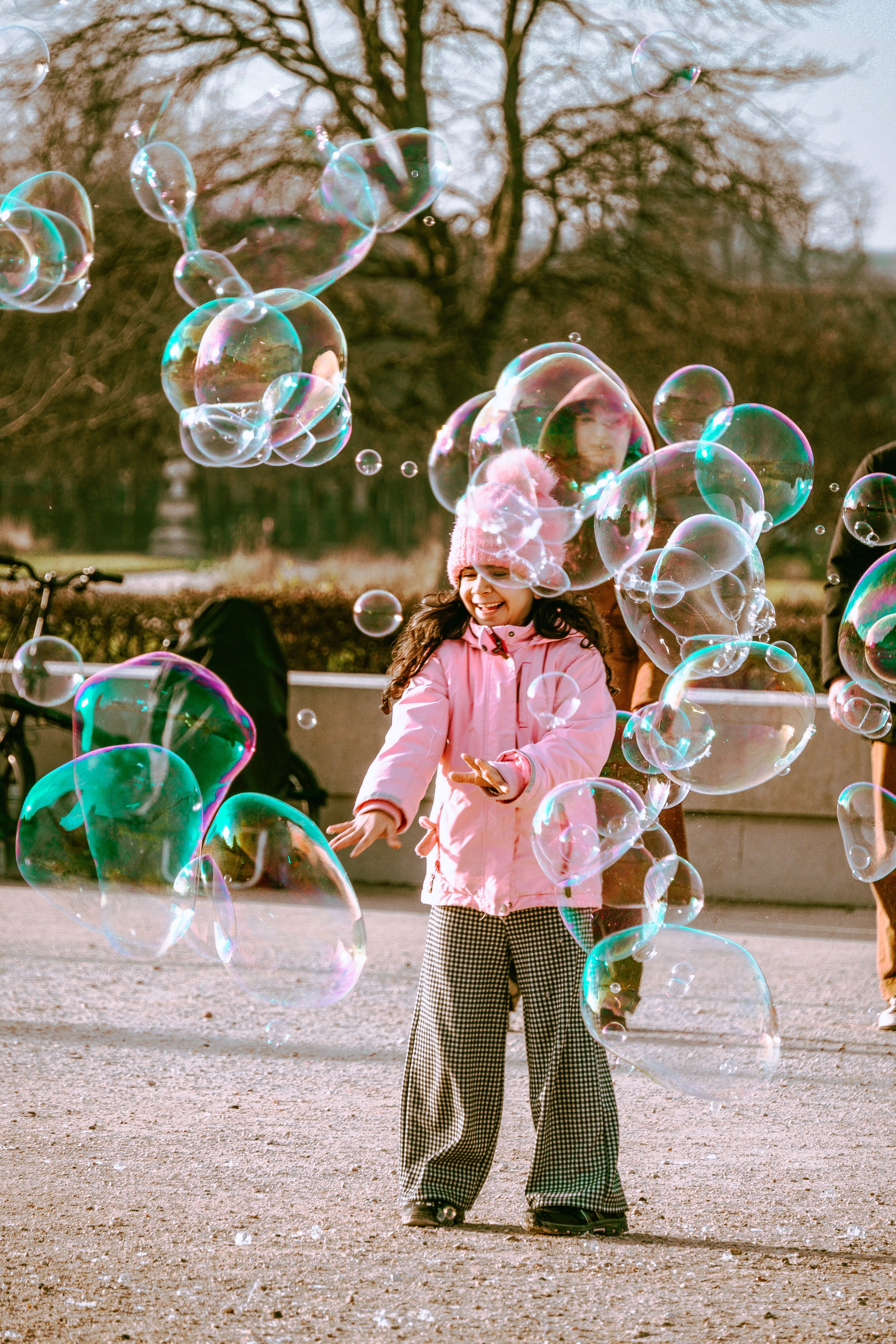 Joyful Child Playing with Bubbles in Paris Park · Free Stock Photo