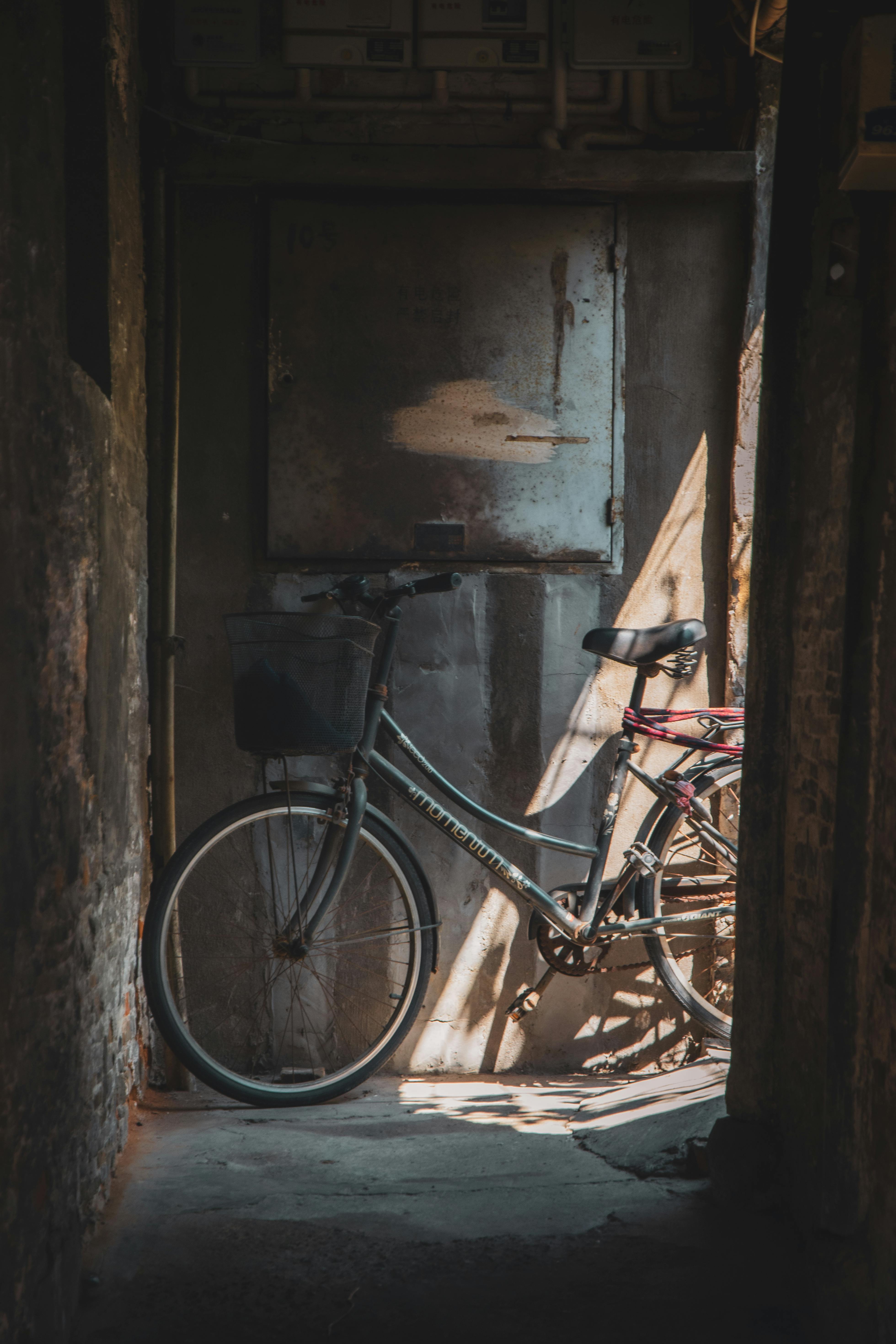 Old Bicycle Resting in a Dimly Lit Alleyway · Free Stock Photo