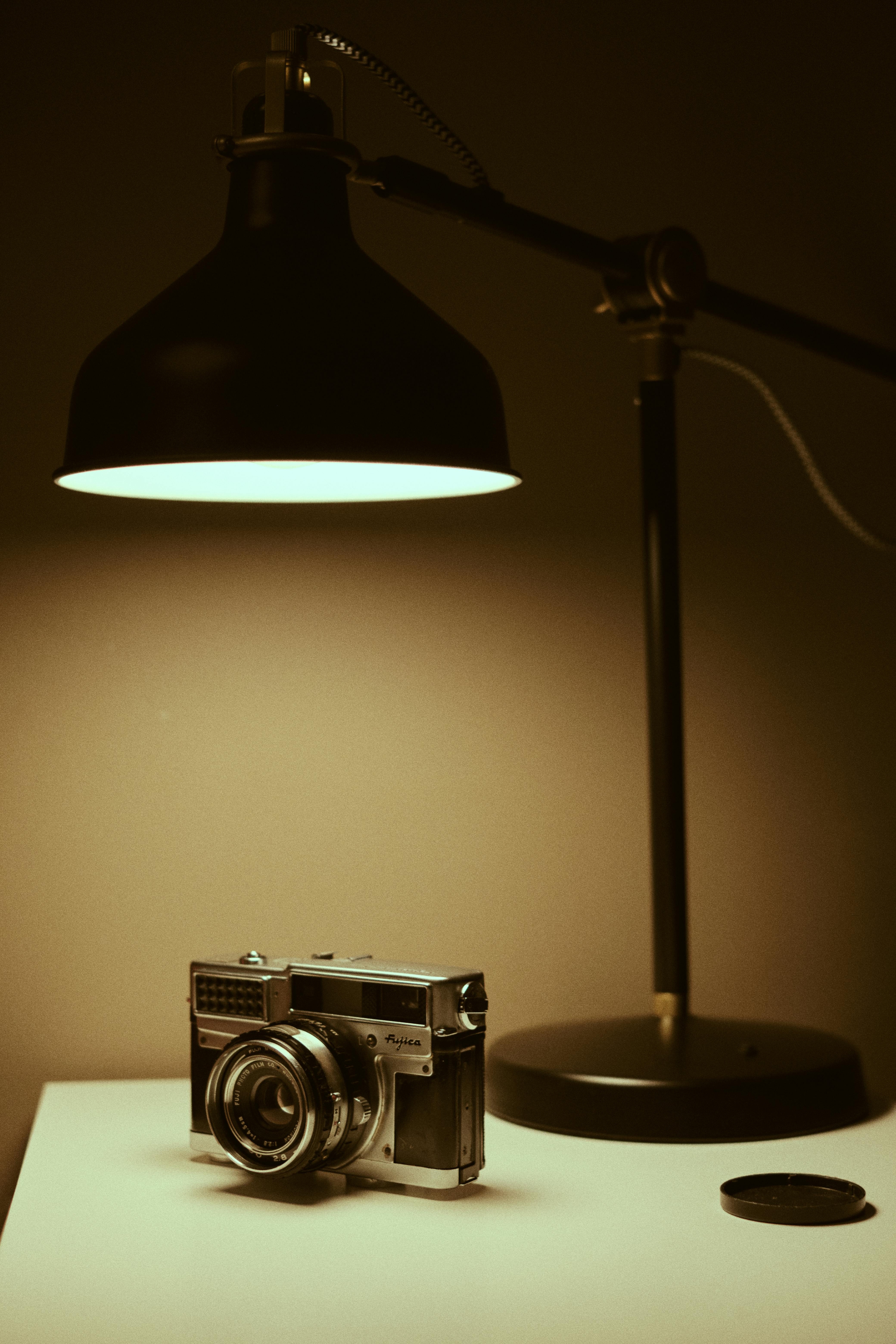 Vintage Camera Under Warm Lamp Light · Free Stock Photo