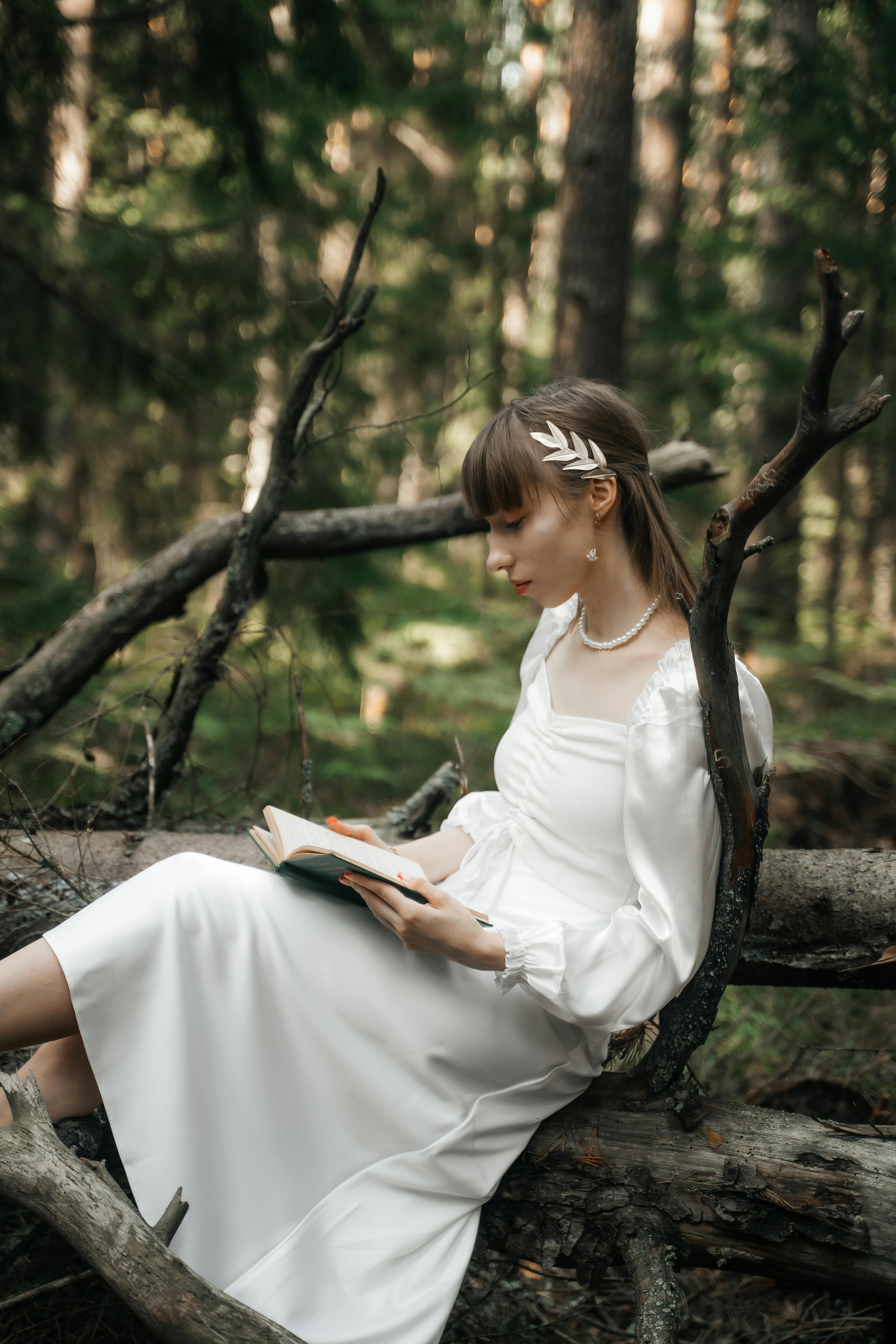 Woman Reading Book in Peaceful Forest Setting · Free Stock Photo