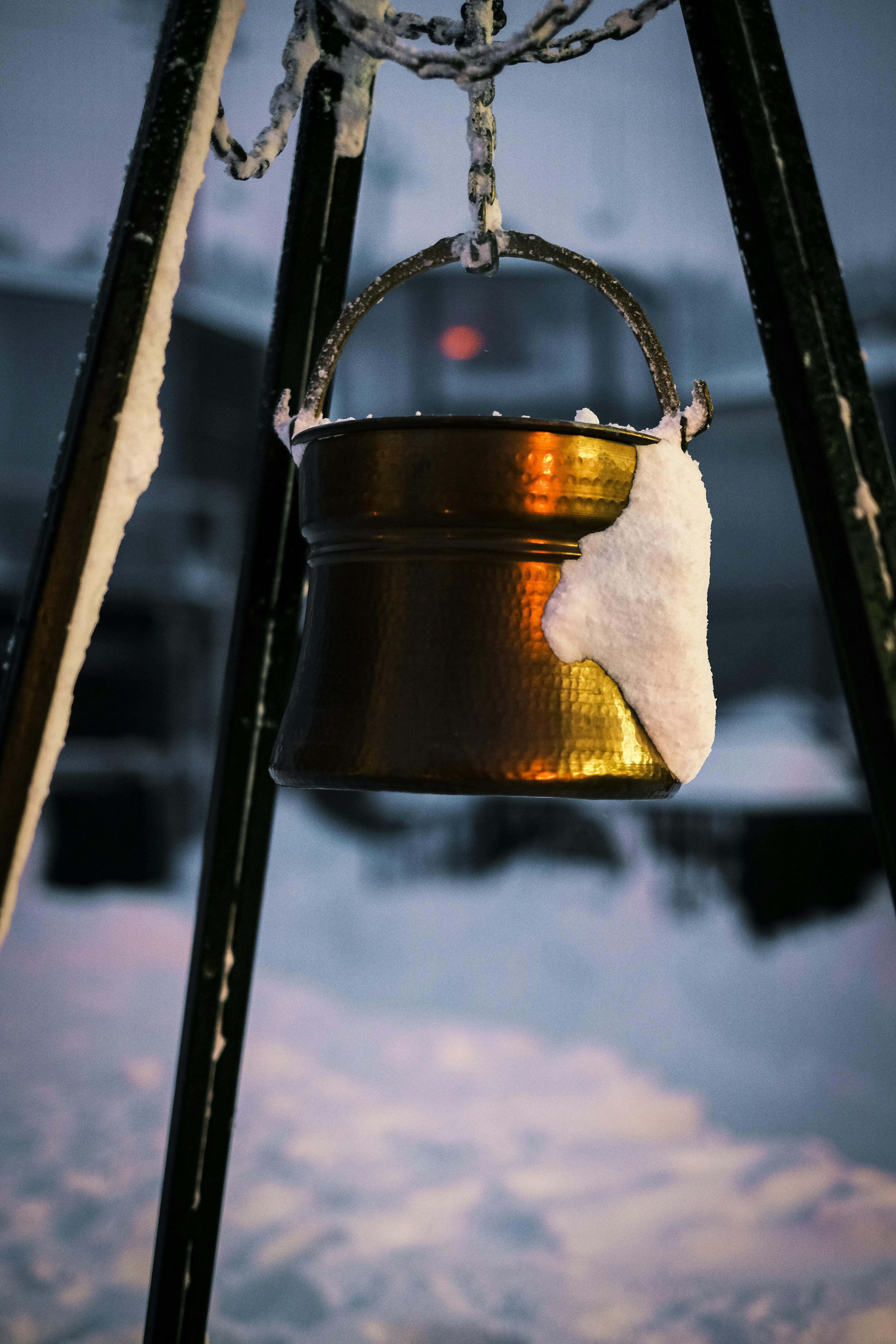 Winter Evening with Snow-Covered Antique Cauldron · Free Stock Photo