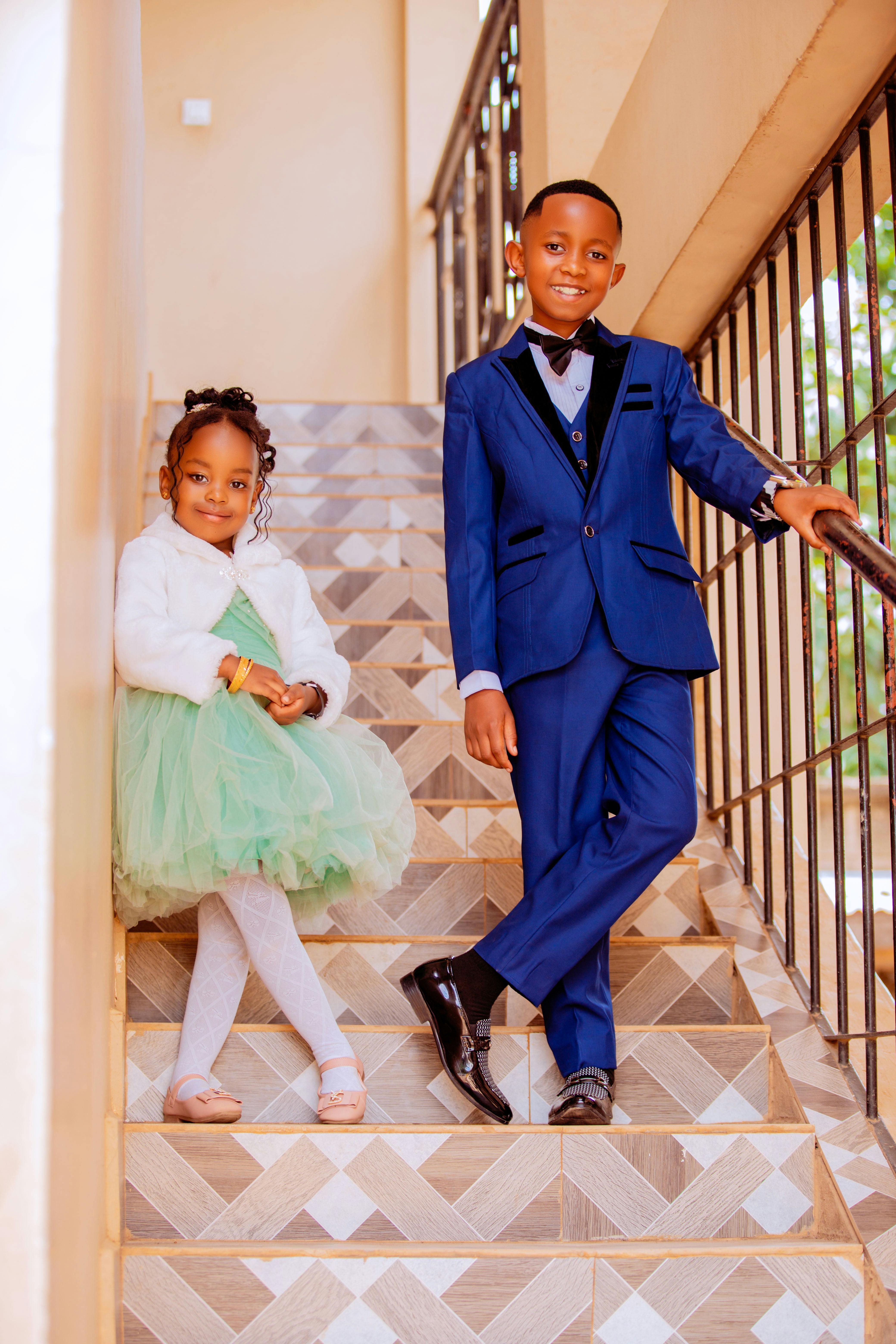 Elegant children in formal attire on staircase · Free Stock Photo