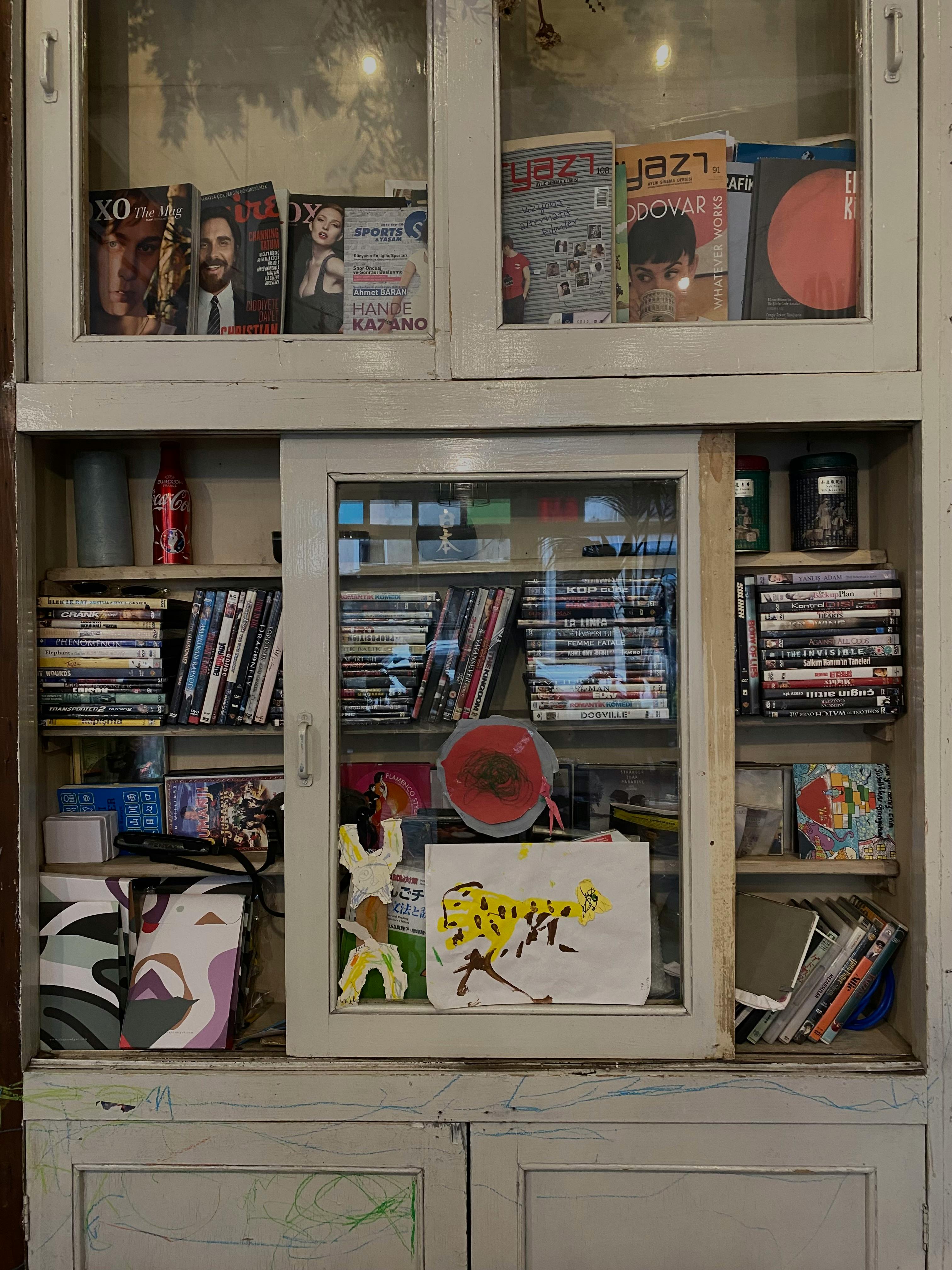 Vintage Cabinet with Magazines and DVDs Display · Free Stock Photo