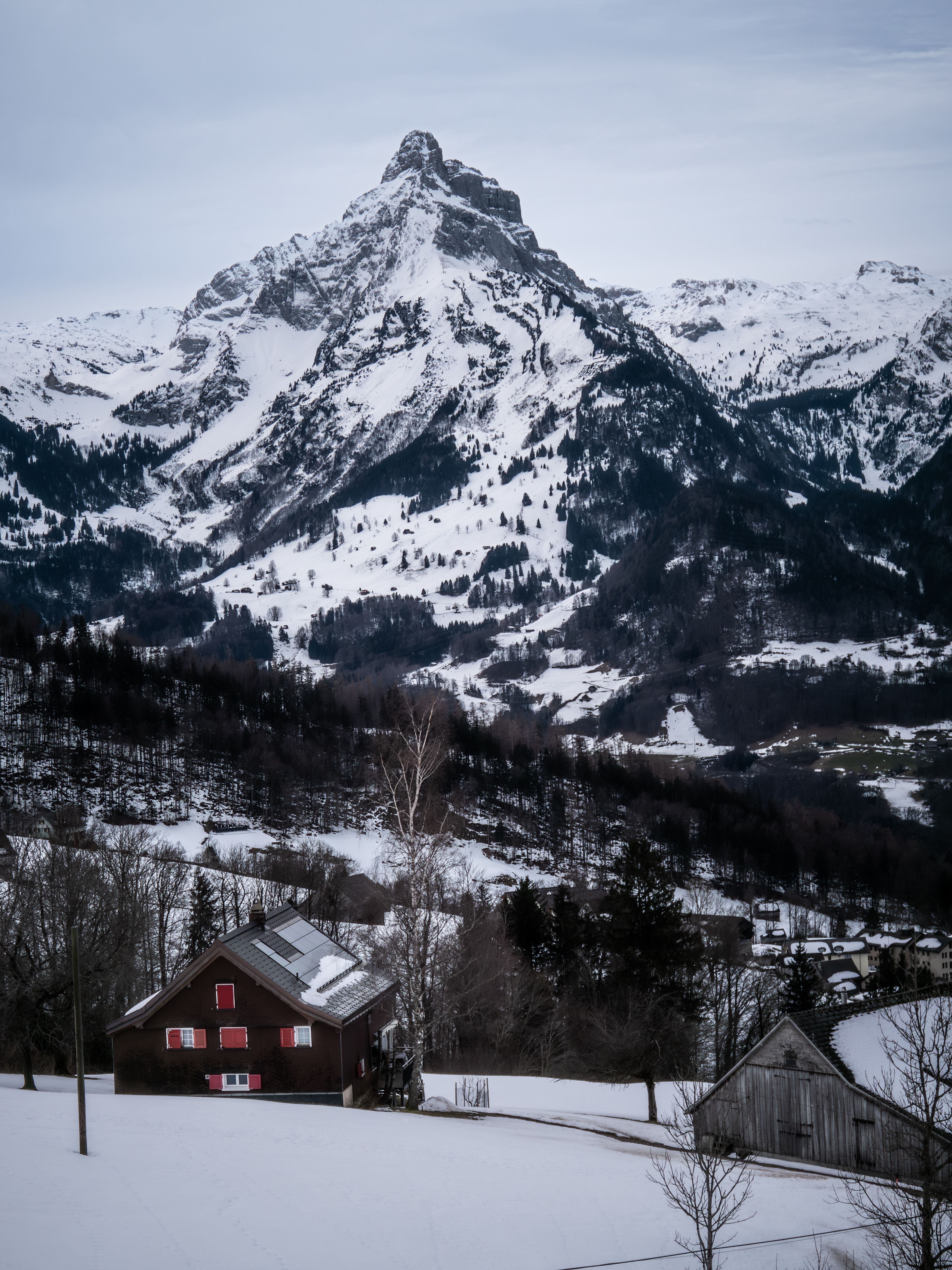 Snow-Covered Swiss Alps and Rustic Cabin in Amden · Free Stock Photo