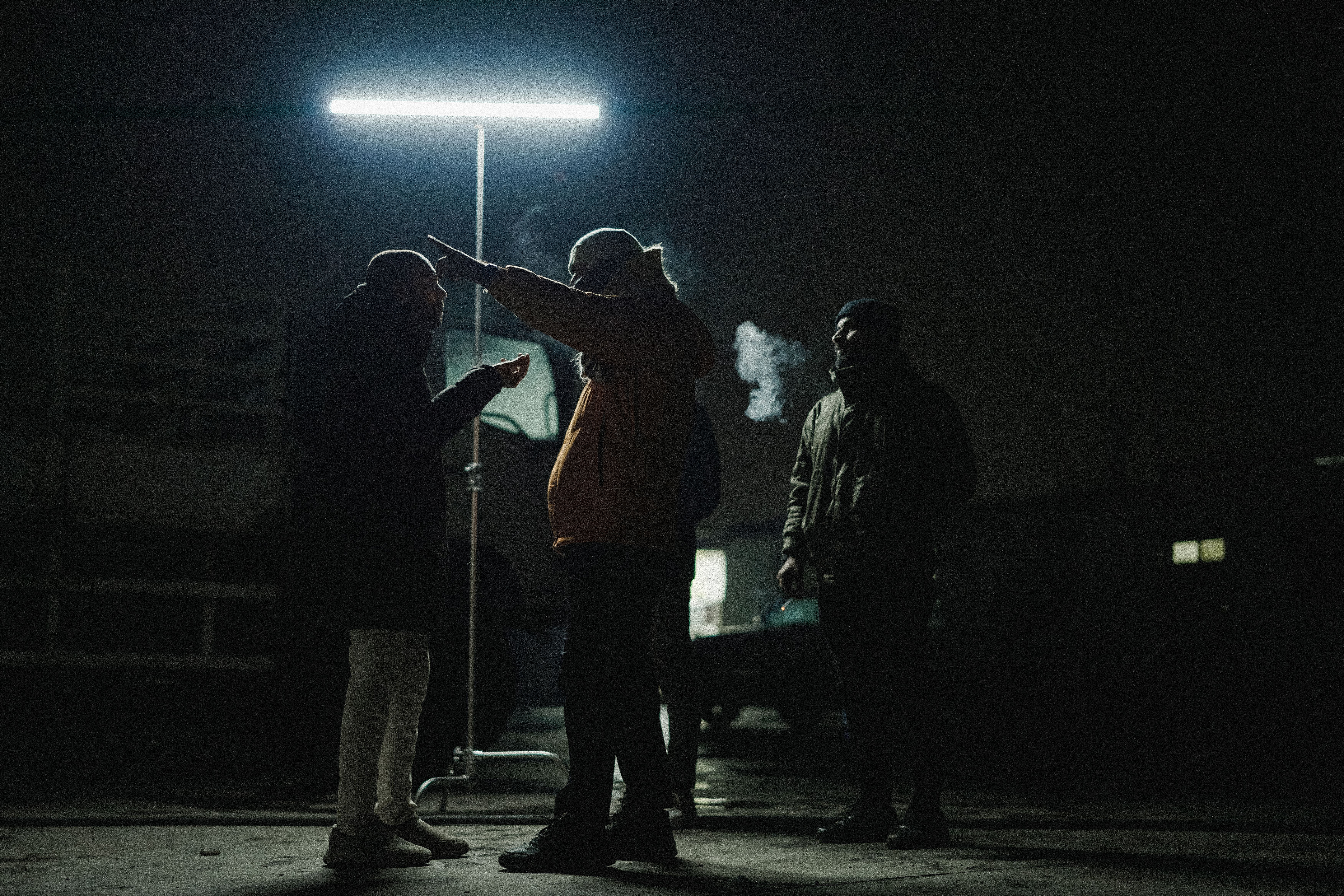 Nighttime Urban Street Scene with Group of Men · Free Stock Photo