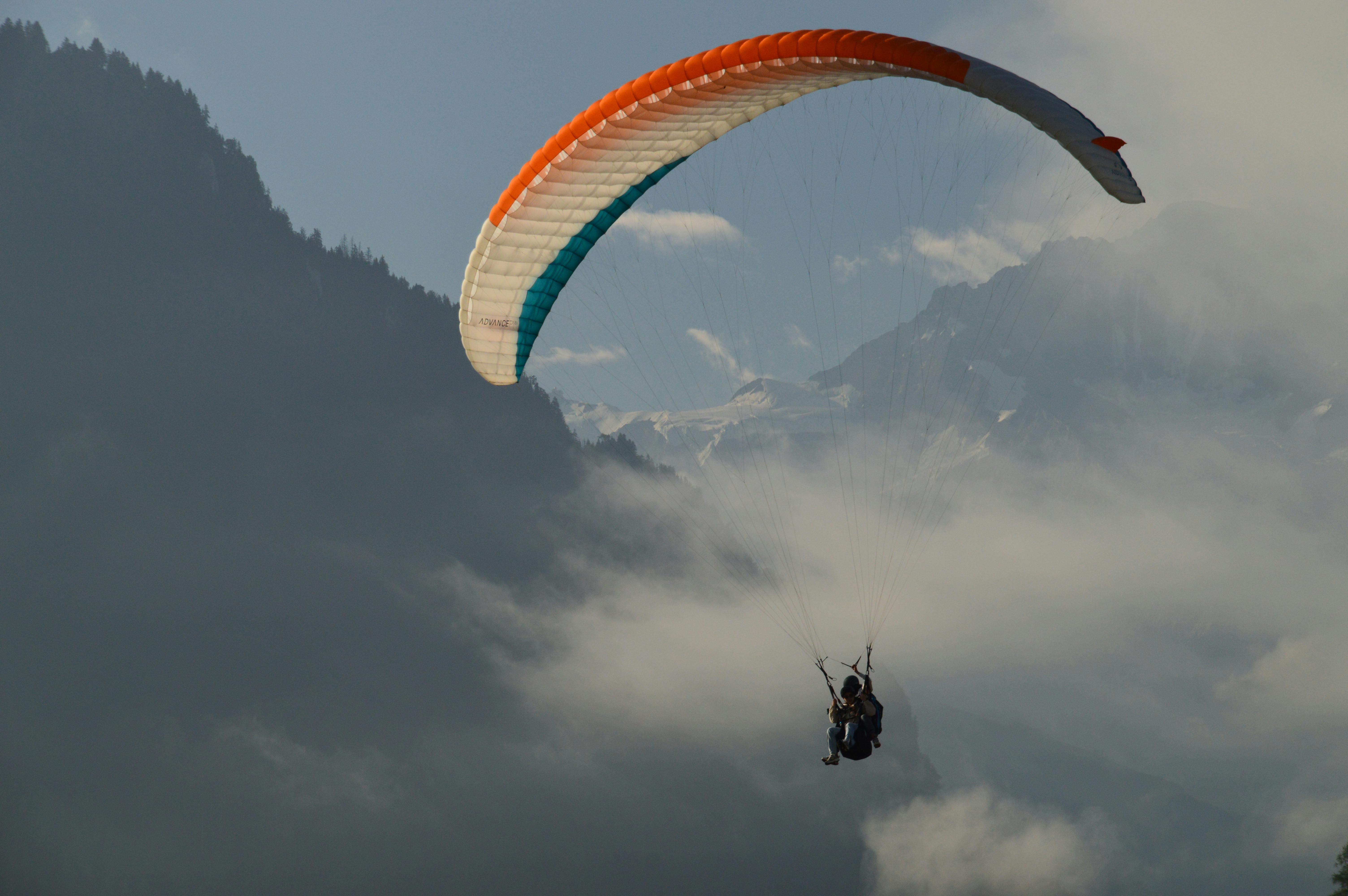 Paraglider Soaring Above Swiss Alps · Free Stock Photo