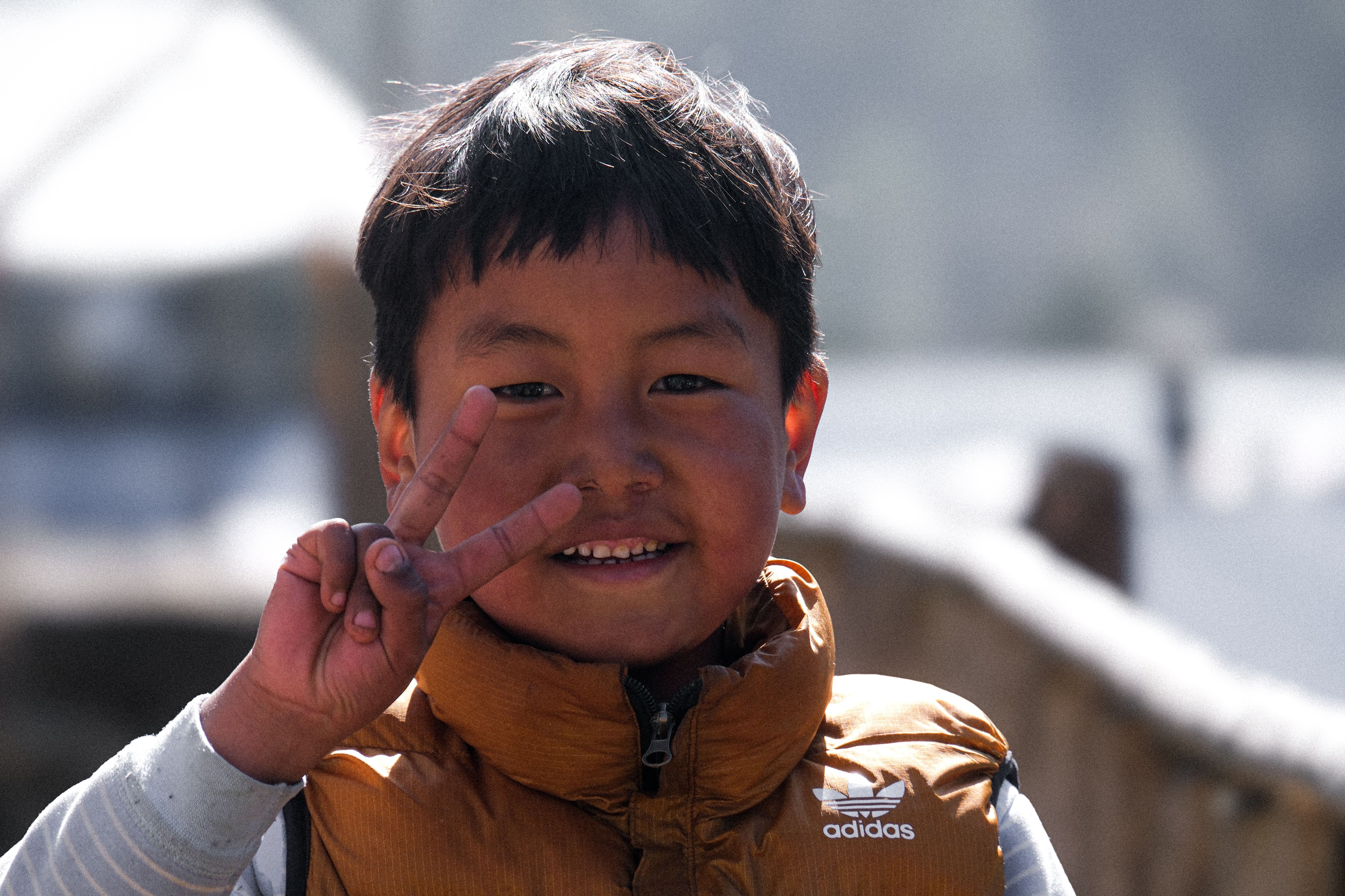 Smiling Child in Nepal Showing Peace Sign · Free Stock Photo