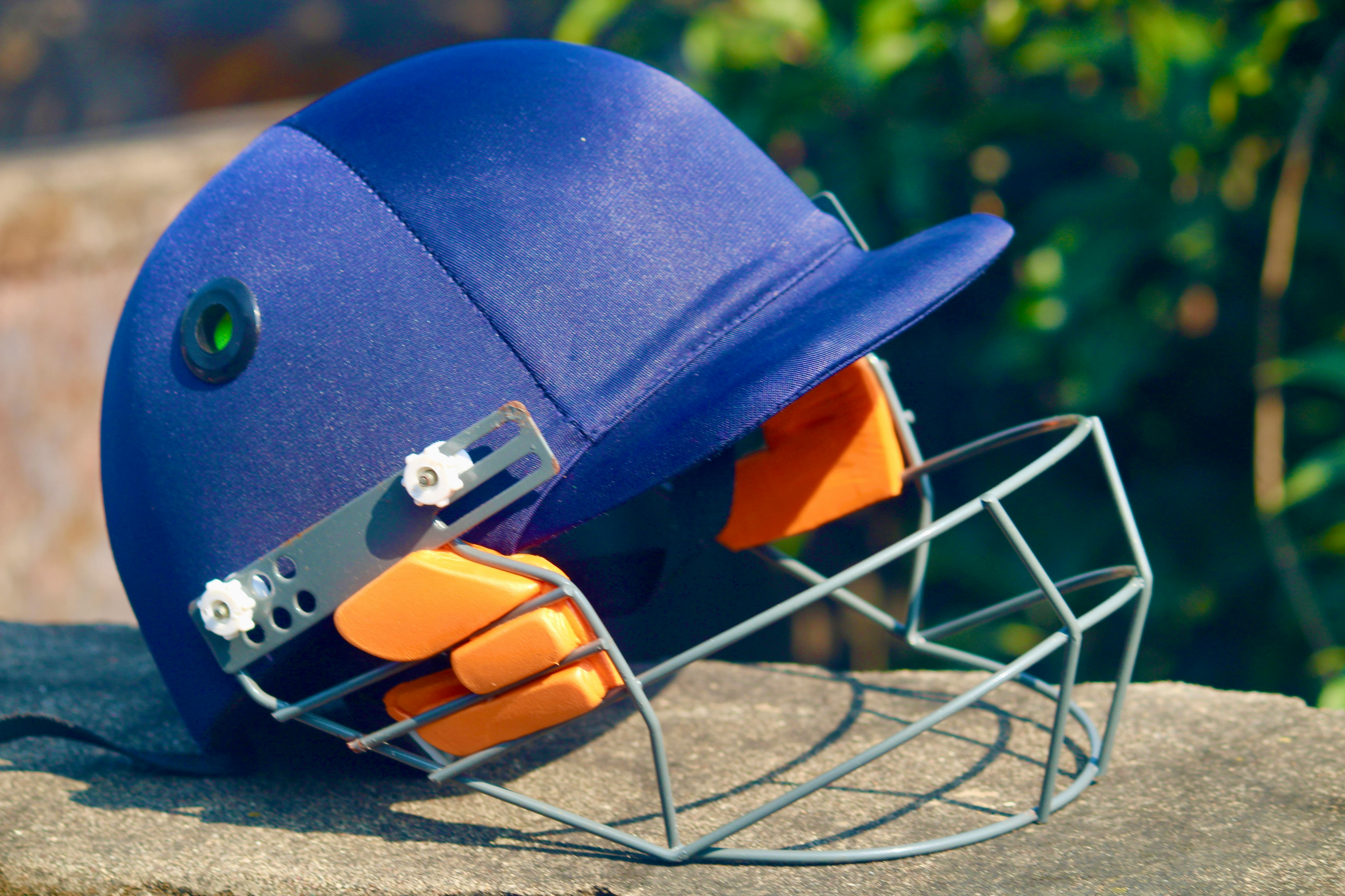 Blue Cricket Helmet on Outdoor Stone Surface · Free Stock Photo