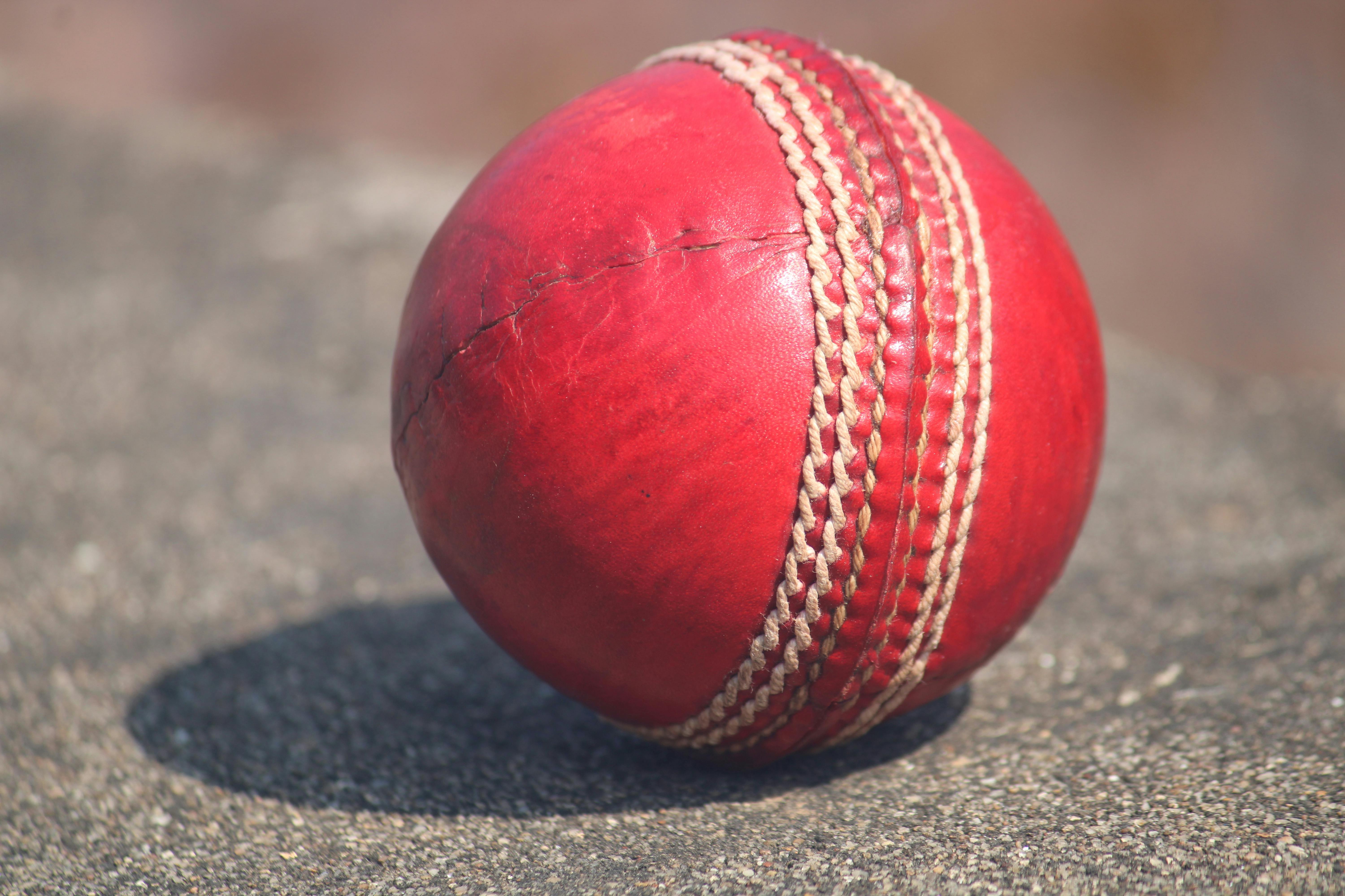 Close-up of a Red Cricket Ball on a Surface · Free Stock Photo