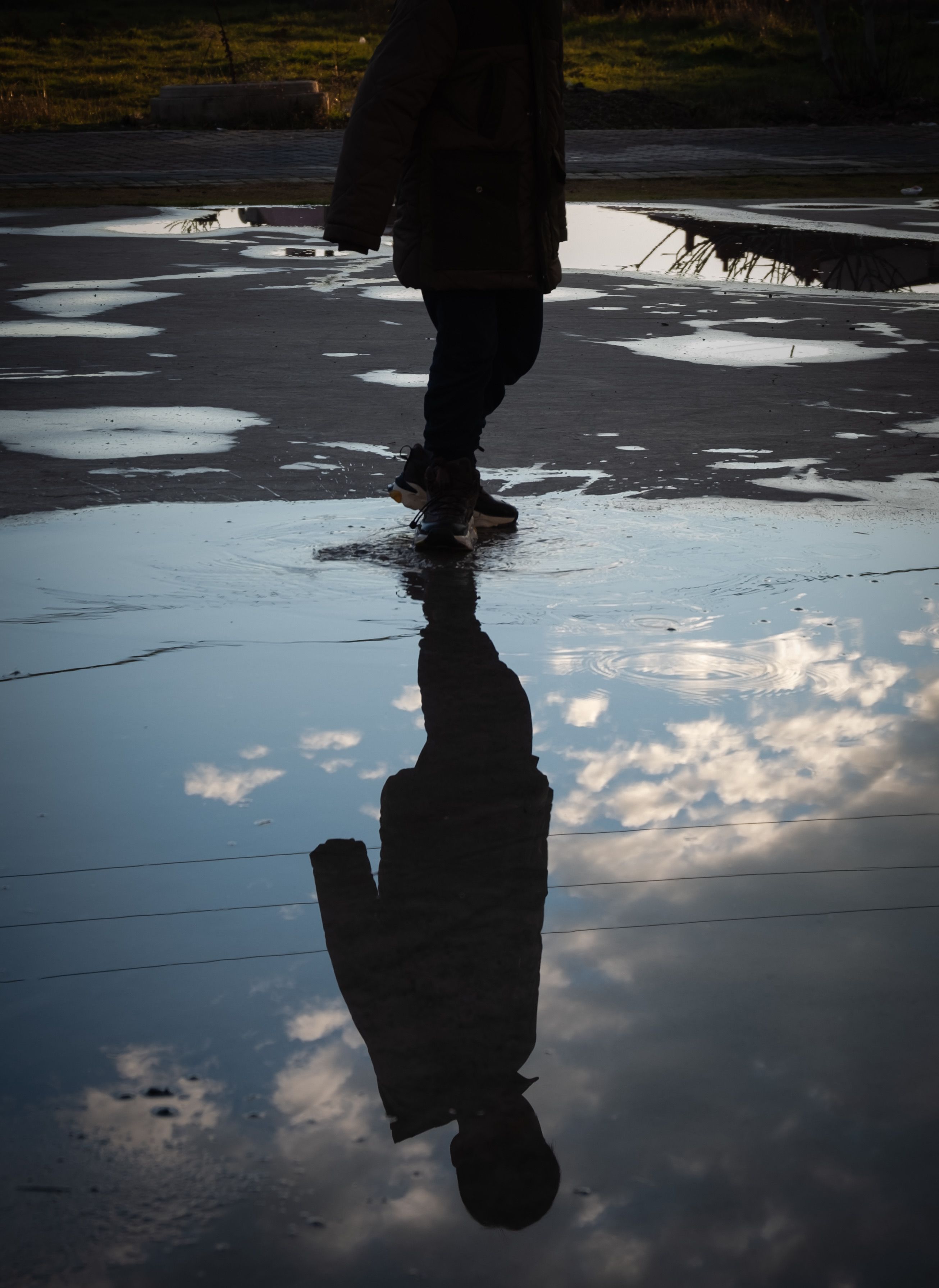 Reflection of a Person Walking in Puddle · Free Stock Photo