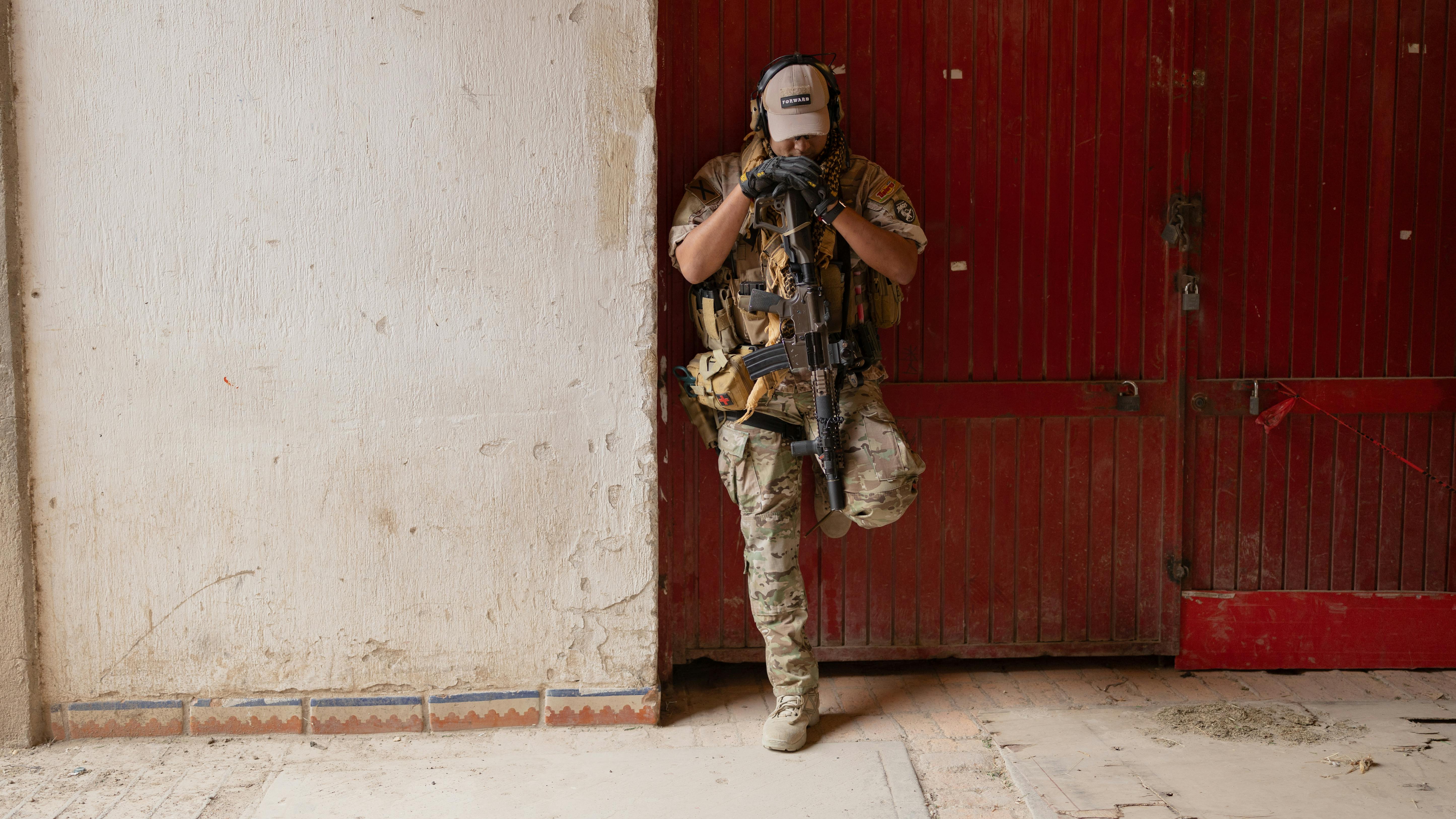 Tactical Soldier Resting Indoors with Gear · Free Stock Photo