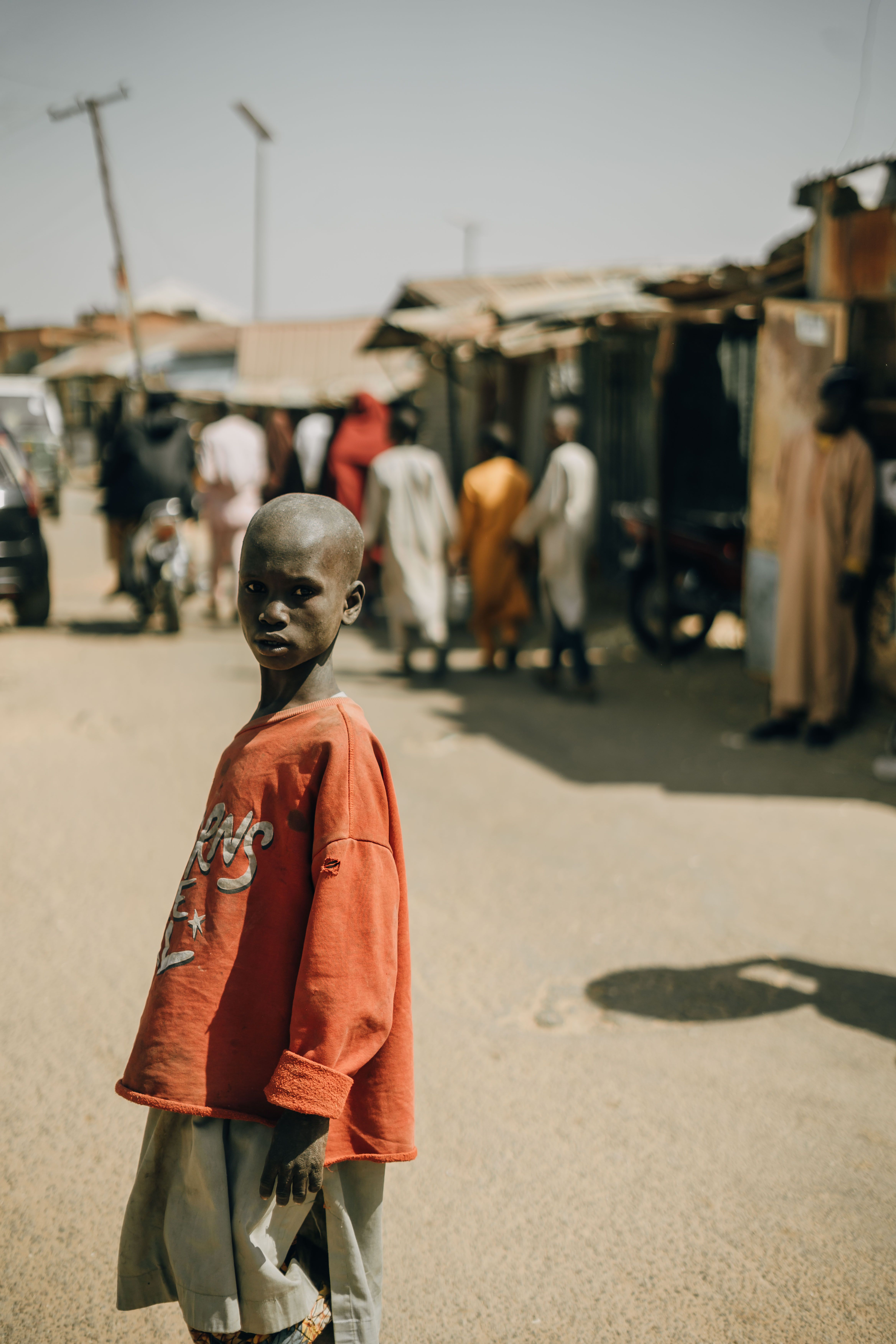 Street Scene with Child in Red Shirt · Free Stock Photo