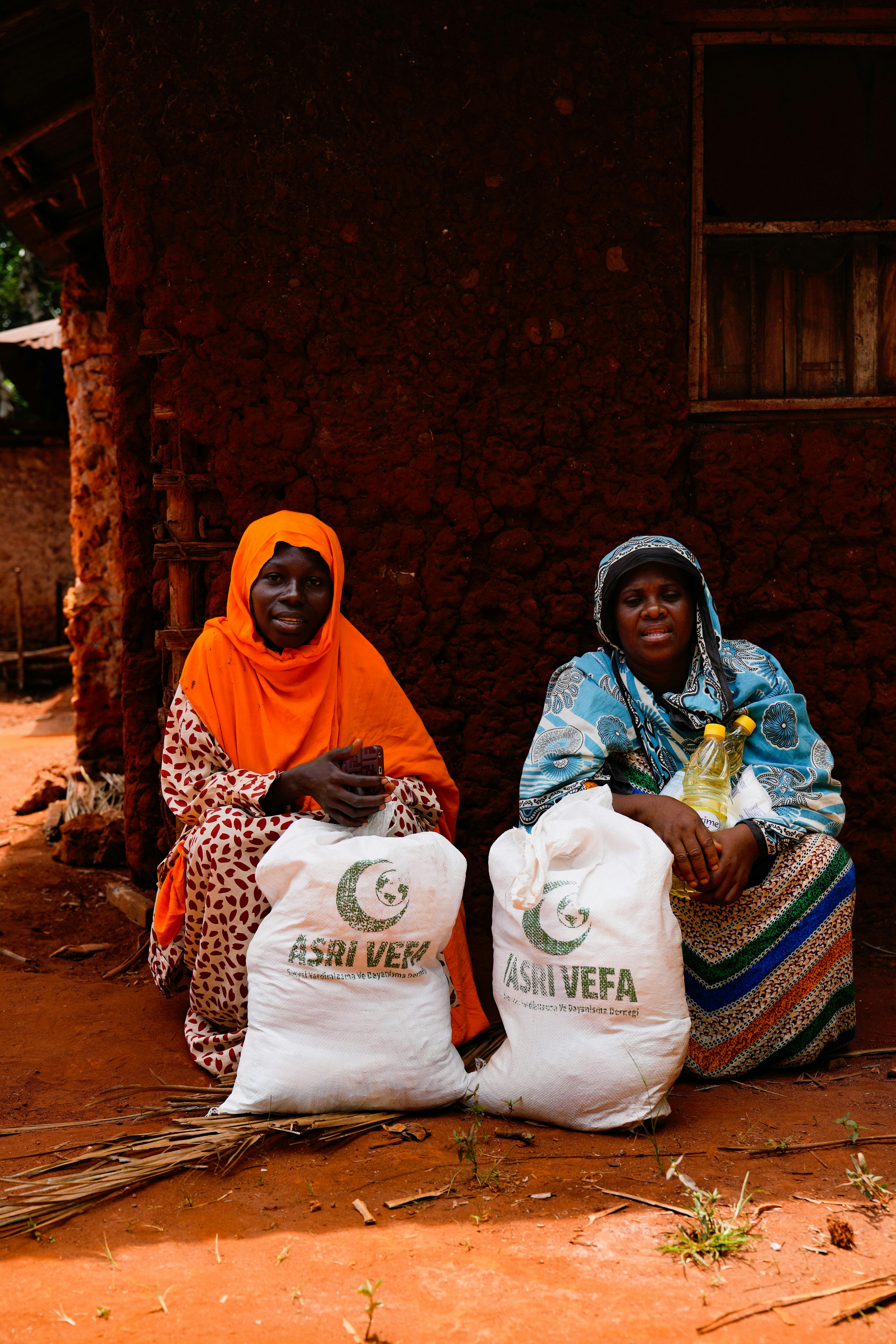 Women with Relief Bags in Rural Setting · Free Stock Photo
