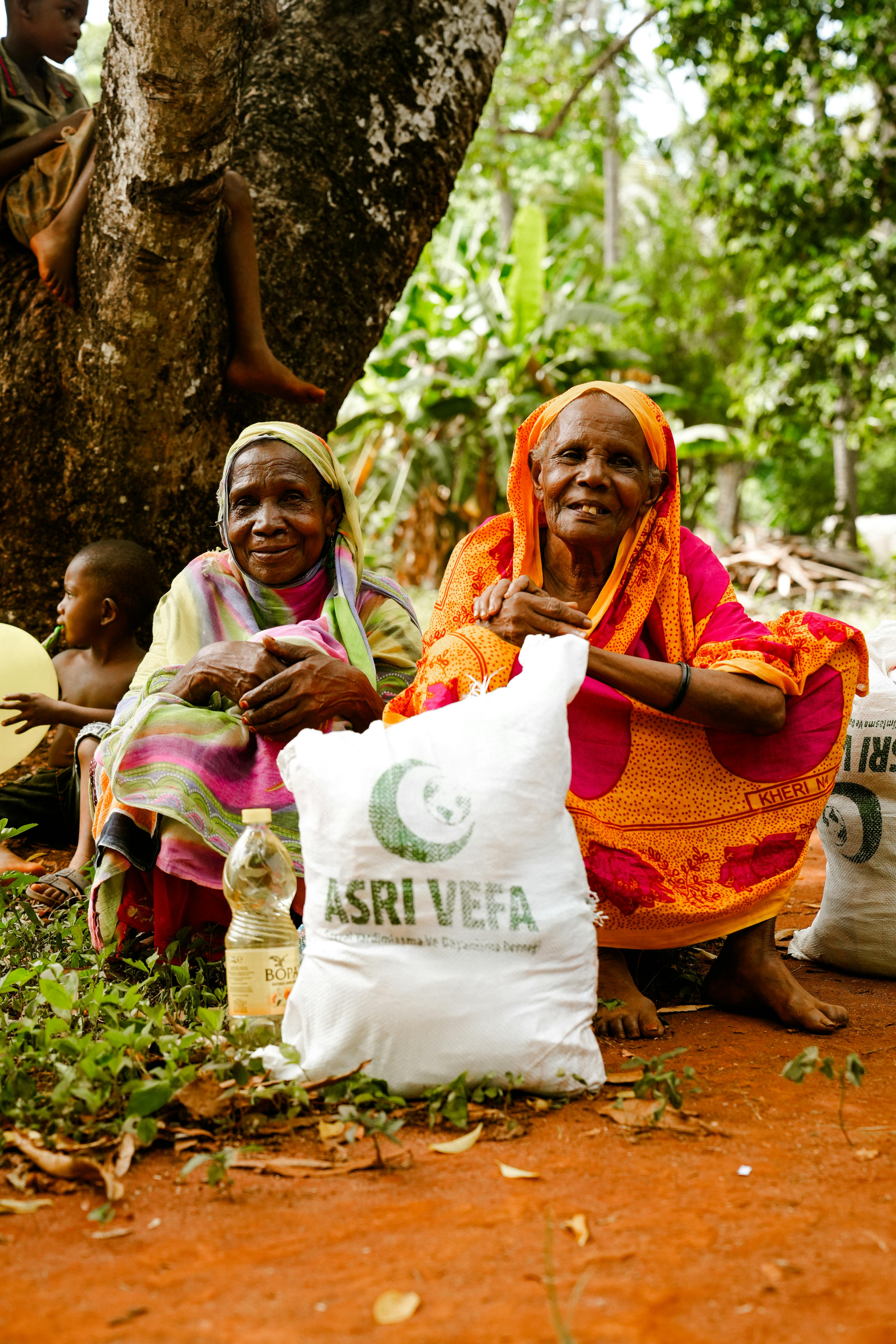 Elderly Women with Aid Packages Outdoors · Free Stock Photo