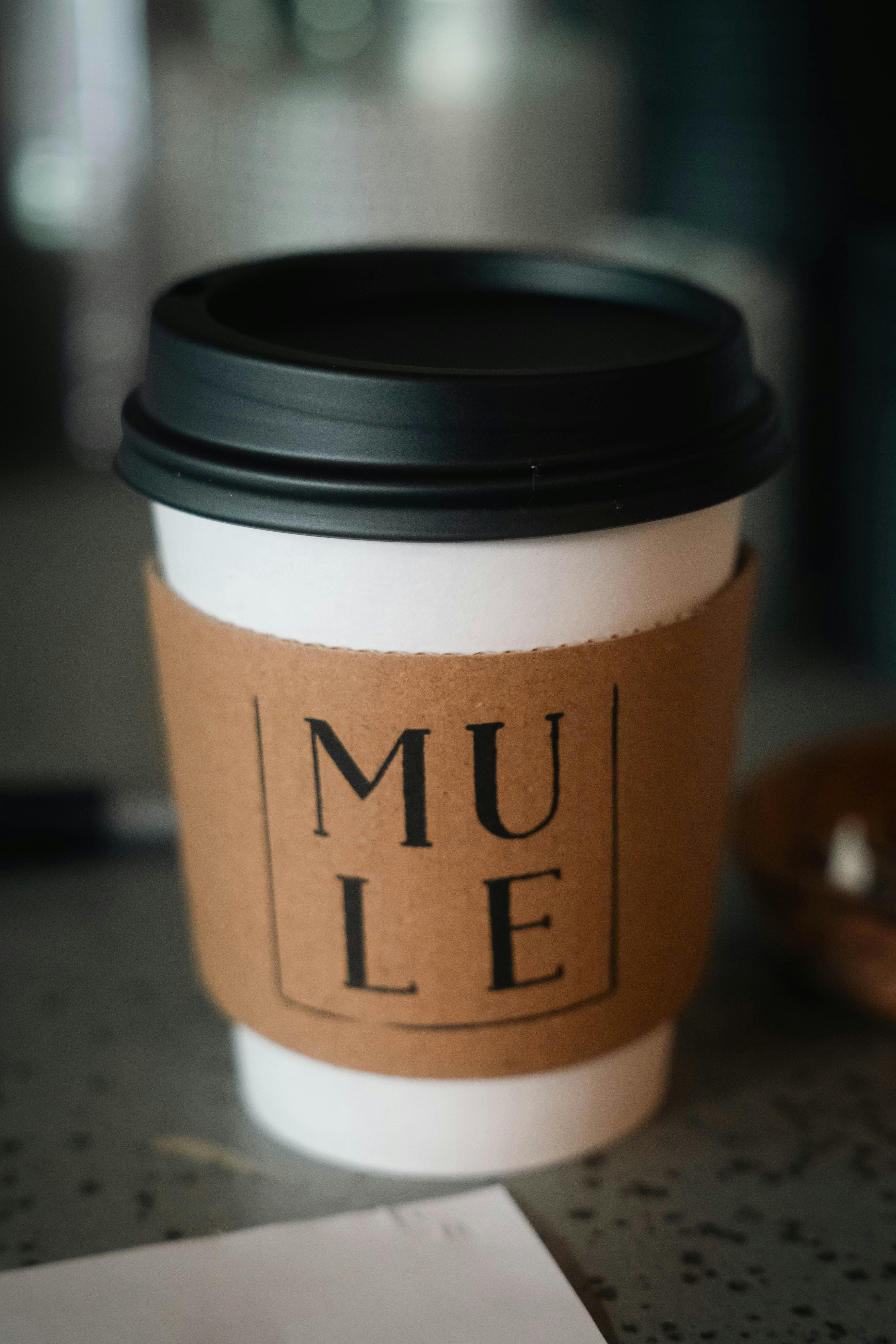 Minimalist Coffee Cup with MULE Branding · Free Stock Photo