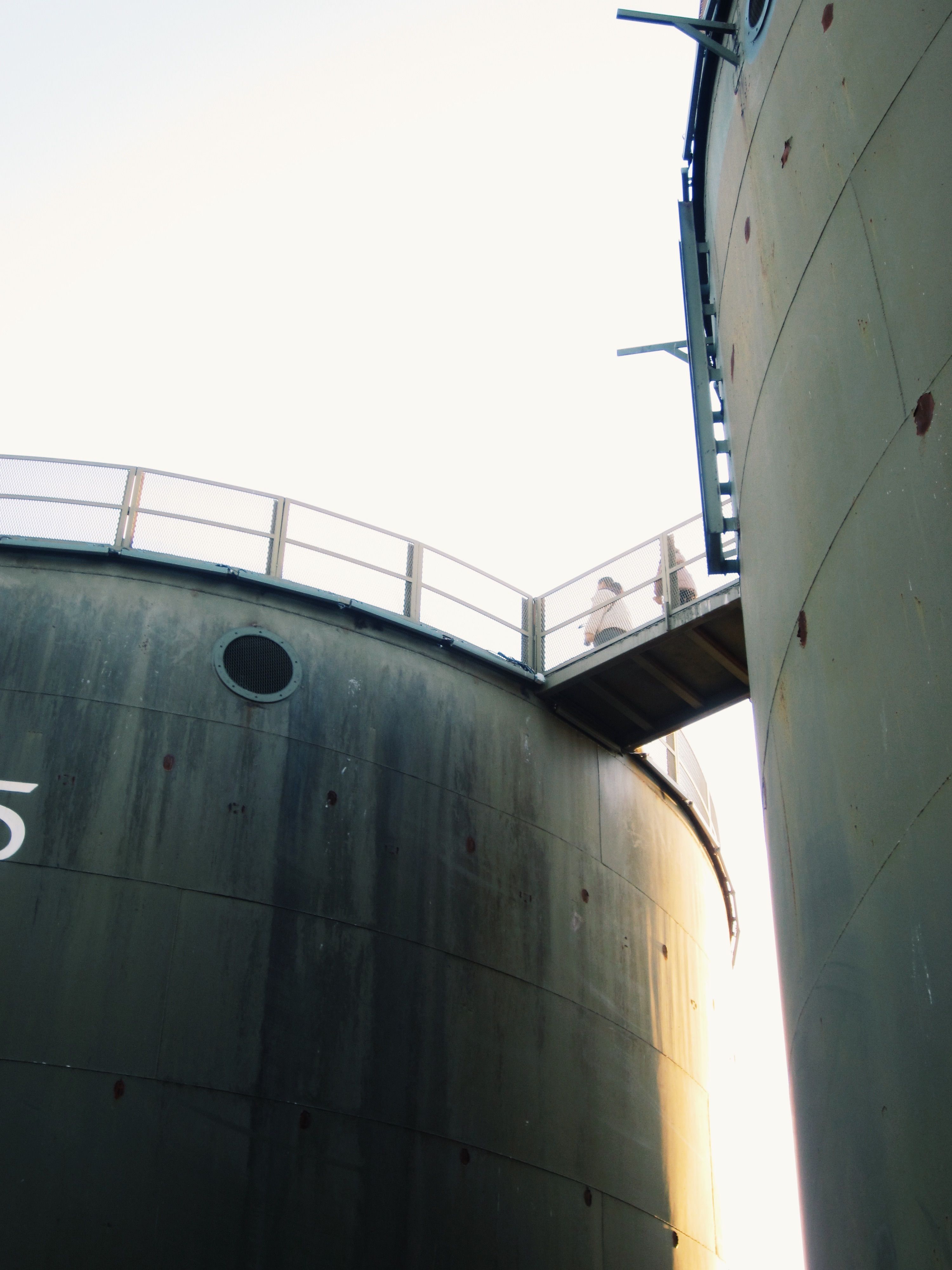 Industrial Silos with Walkway in Soft Light · Free Stock Photo