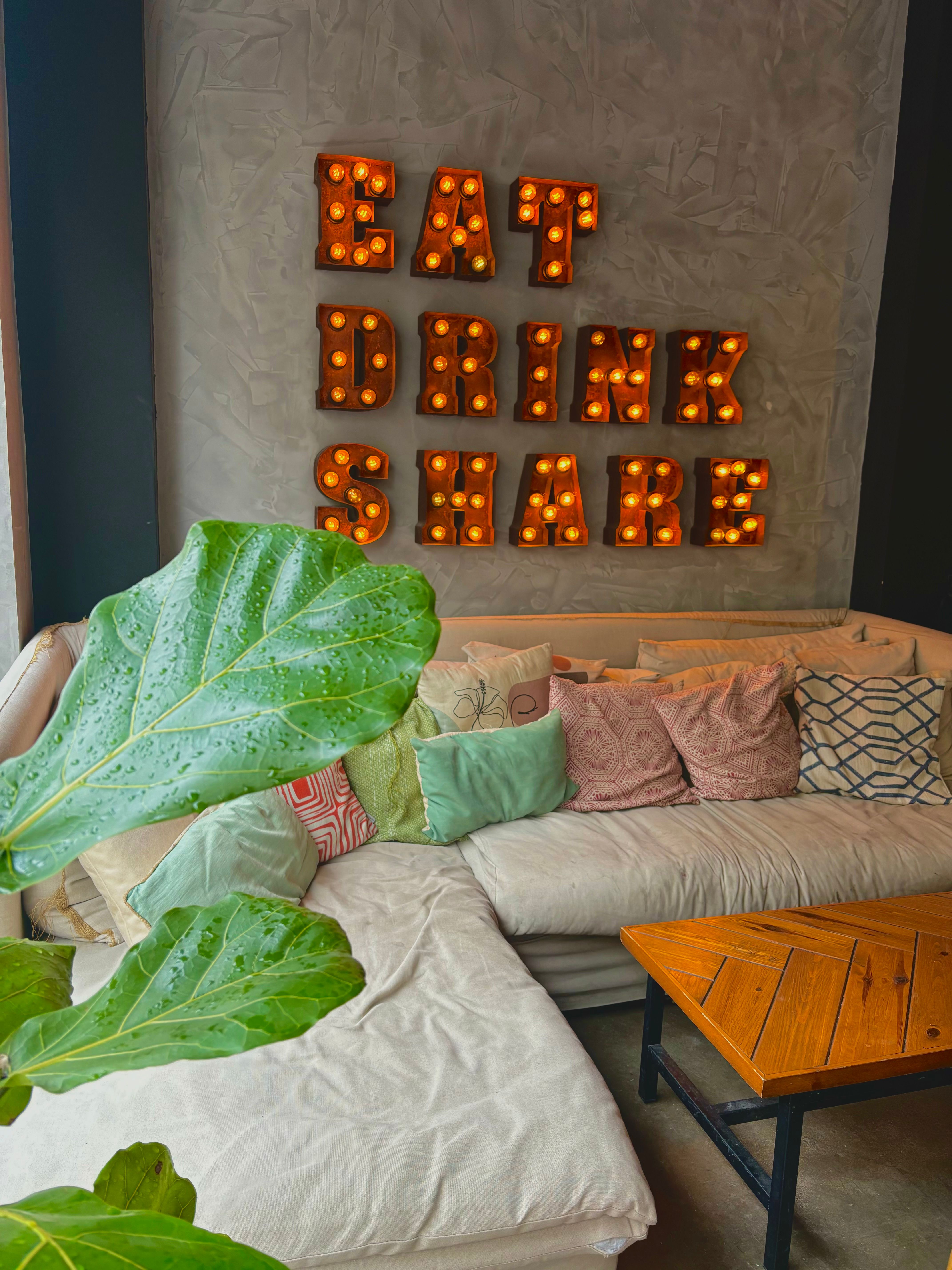 Cozy Lounge with Illuminated Wall Signs · Free Stock Photo
