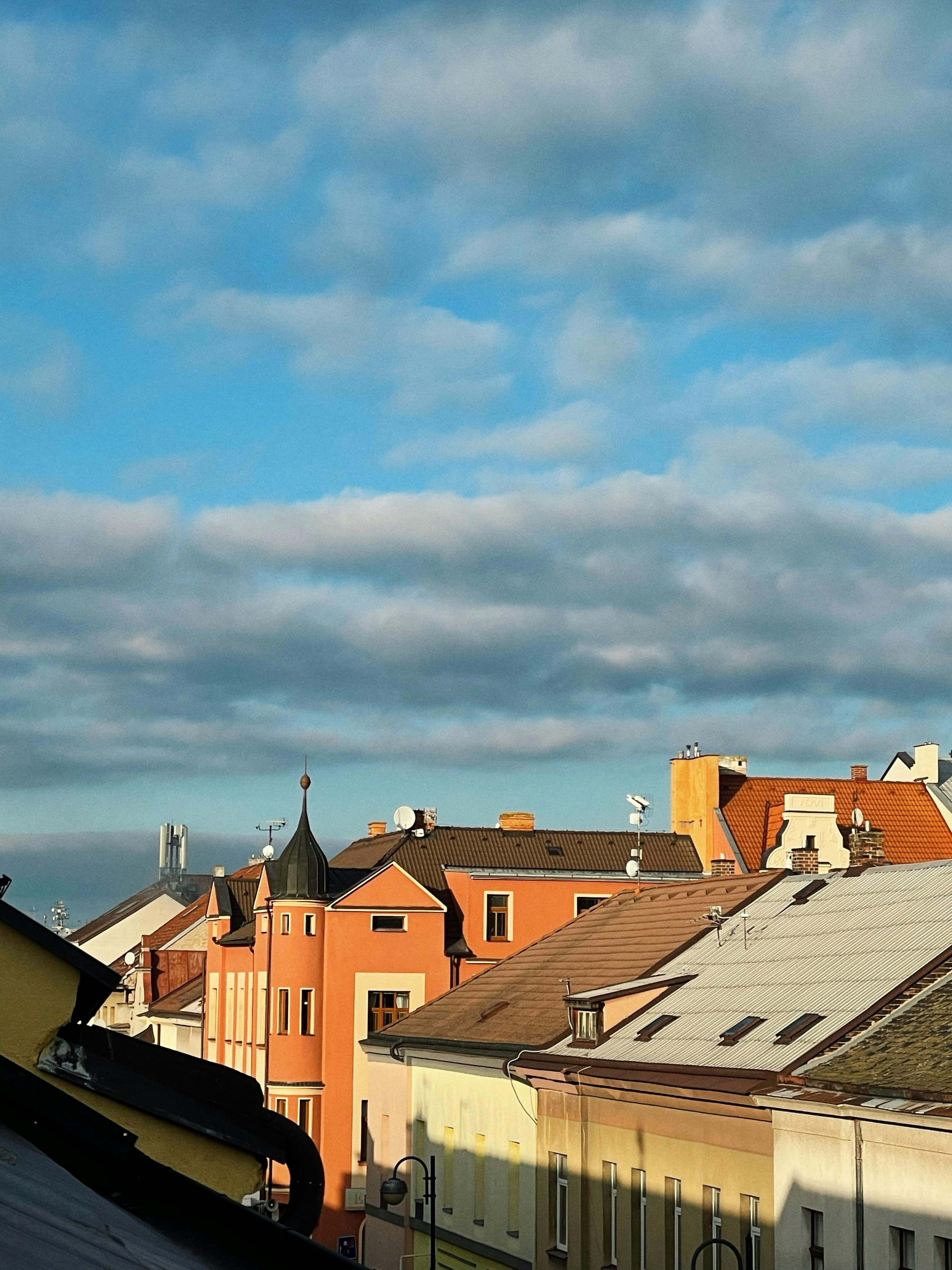 Colorful Rooftops Against a Cloudy Sky · Free Stock Photo