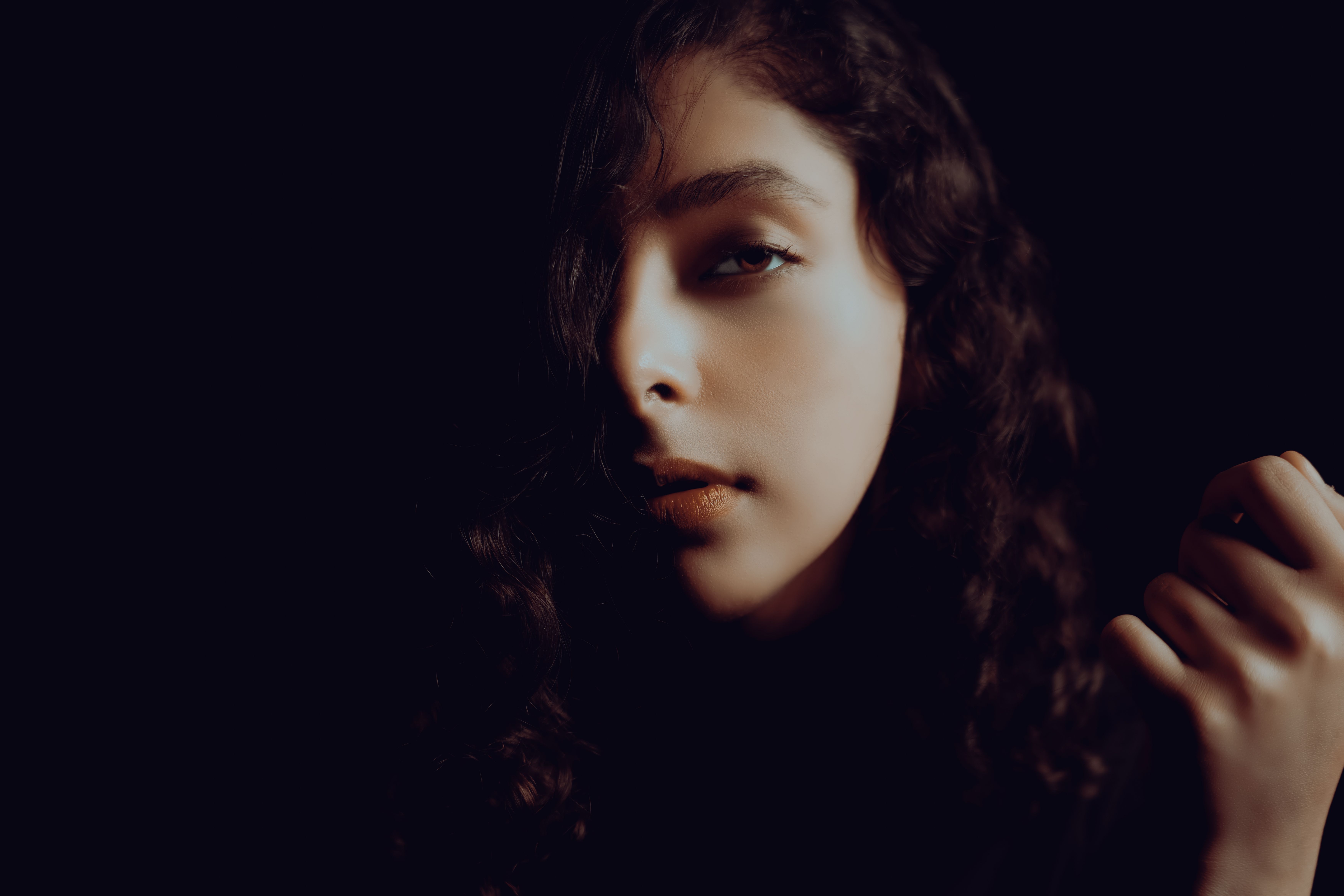 Moody Portrait of a Woman in Low Light · Free Stock Photo