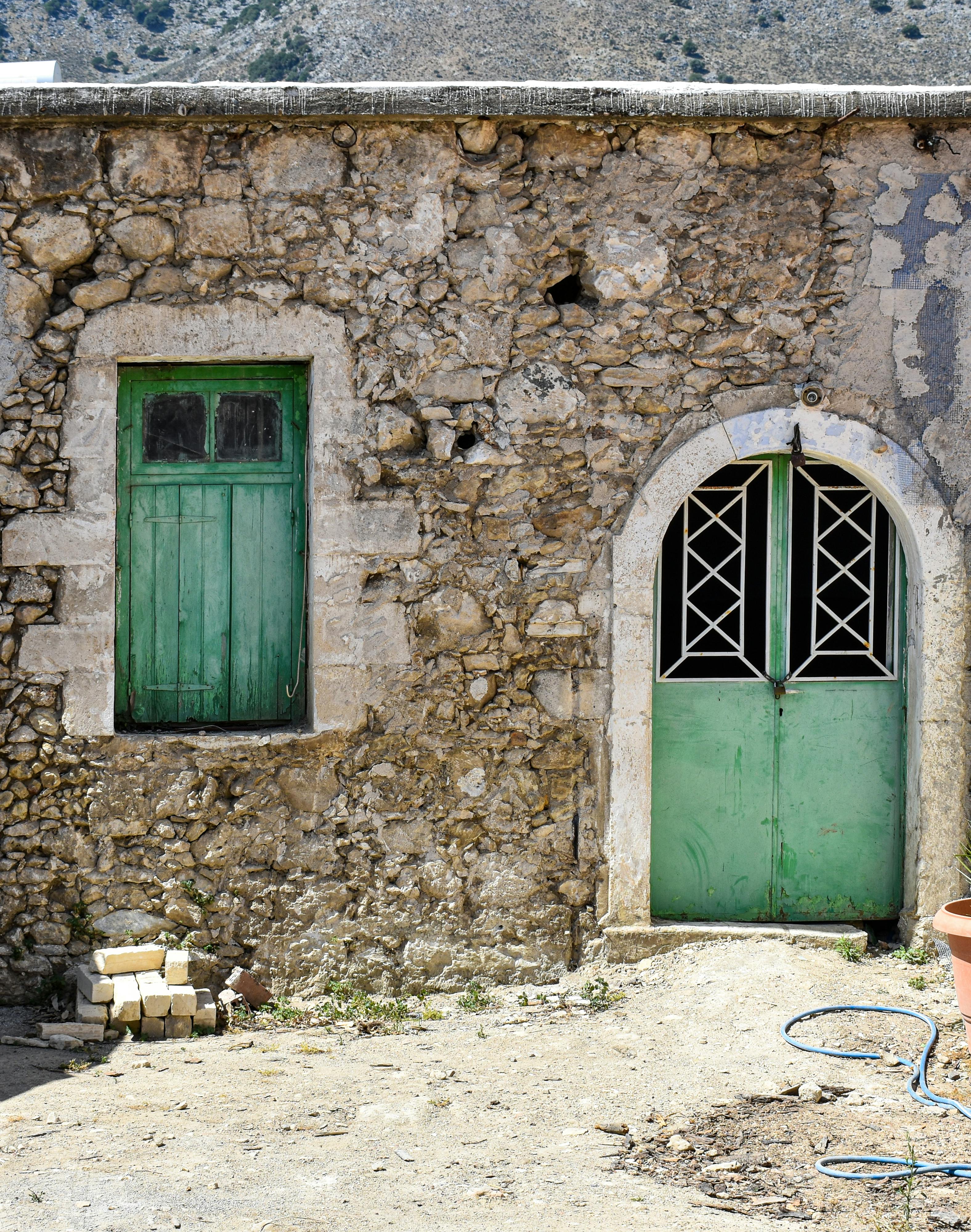 Rustic Stone Building with Green Door and Window · Free Stock Photo