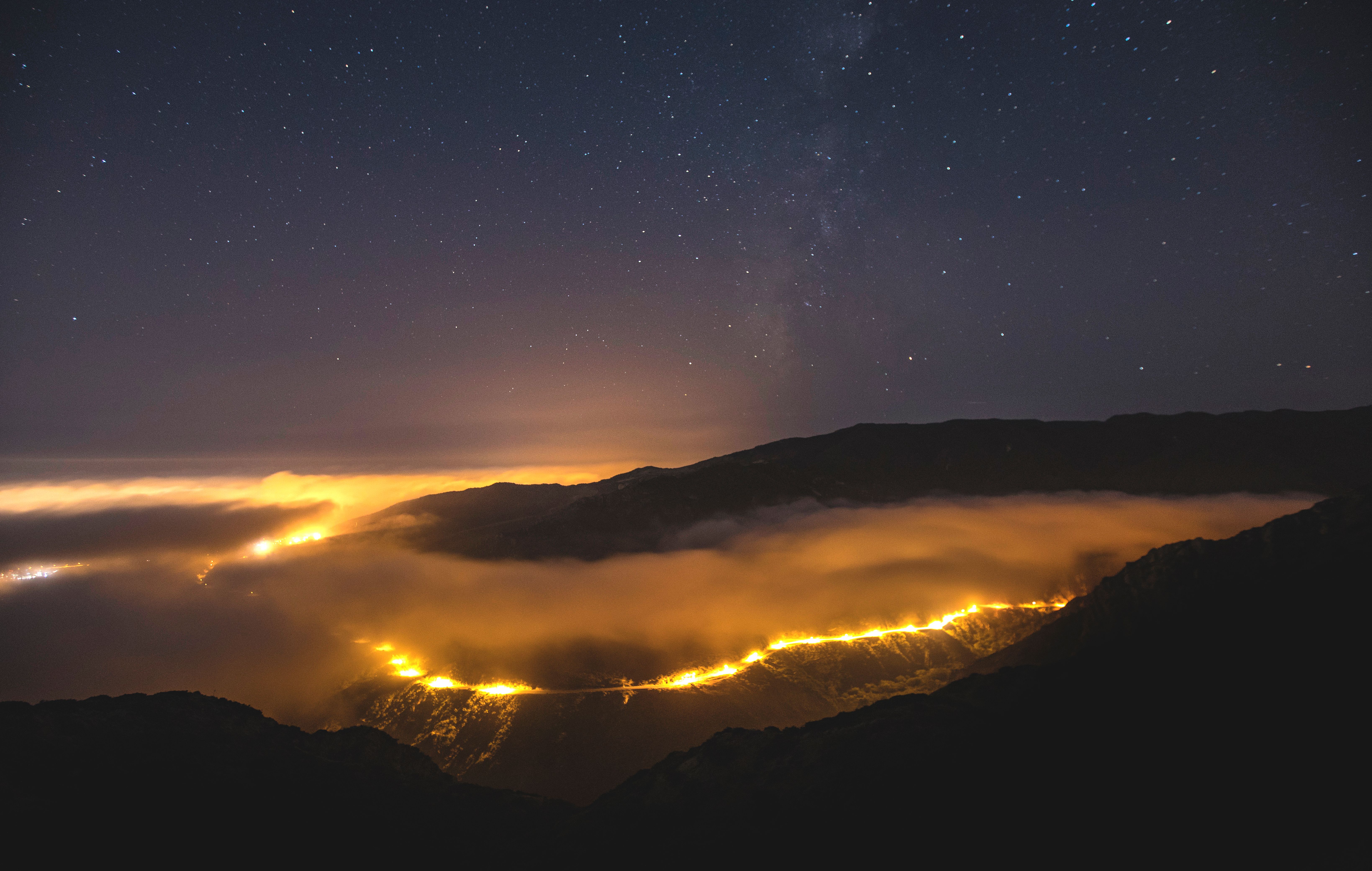 Stunning Night Sky Over Mountain Fire Line · Free Stock Photo