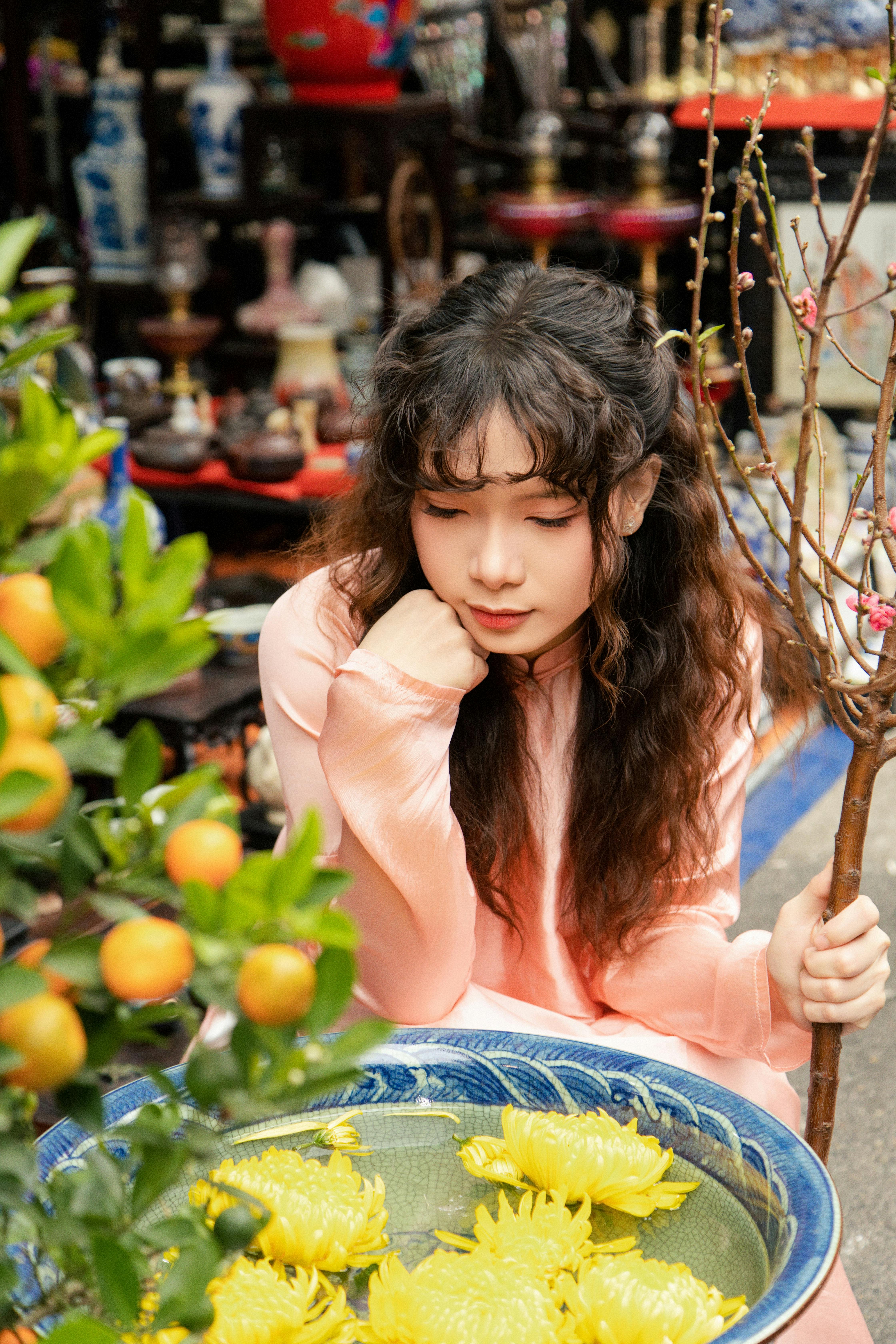 Young Woman Celebrating Tet in Hanoi Market · Free Stock Photo