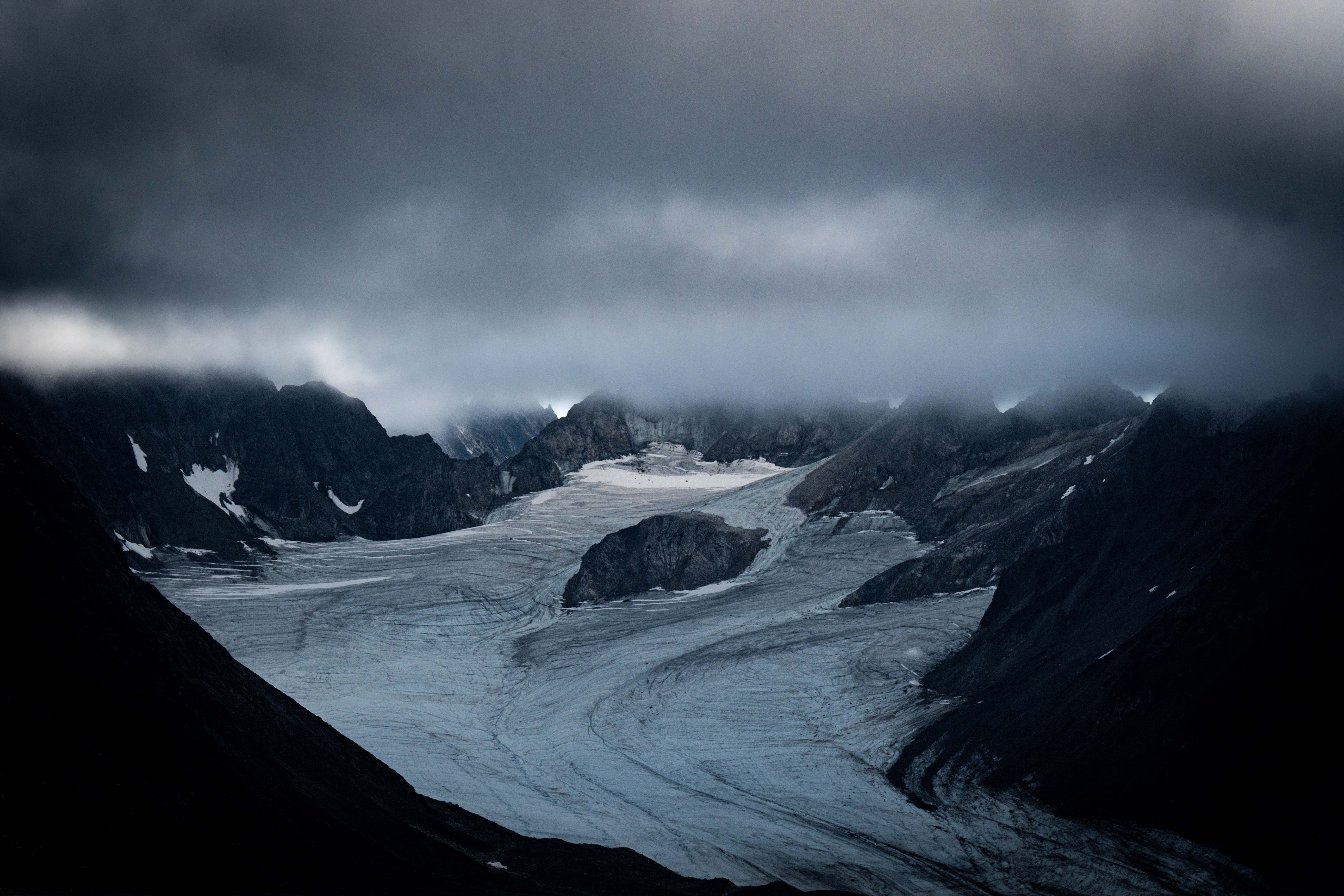 Dramatic Glacier Landscape Under Dark Clouds · Free Stock Photo
