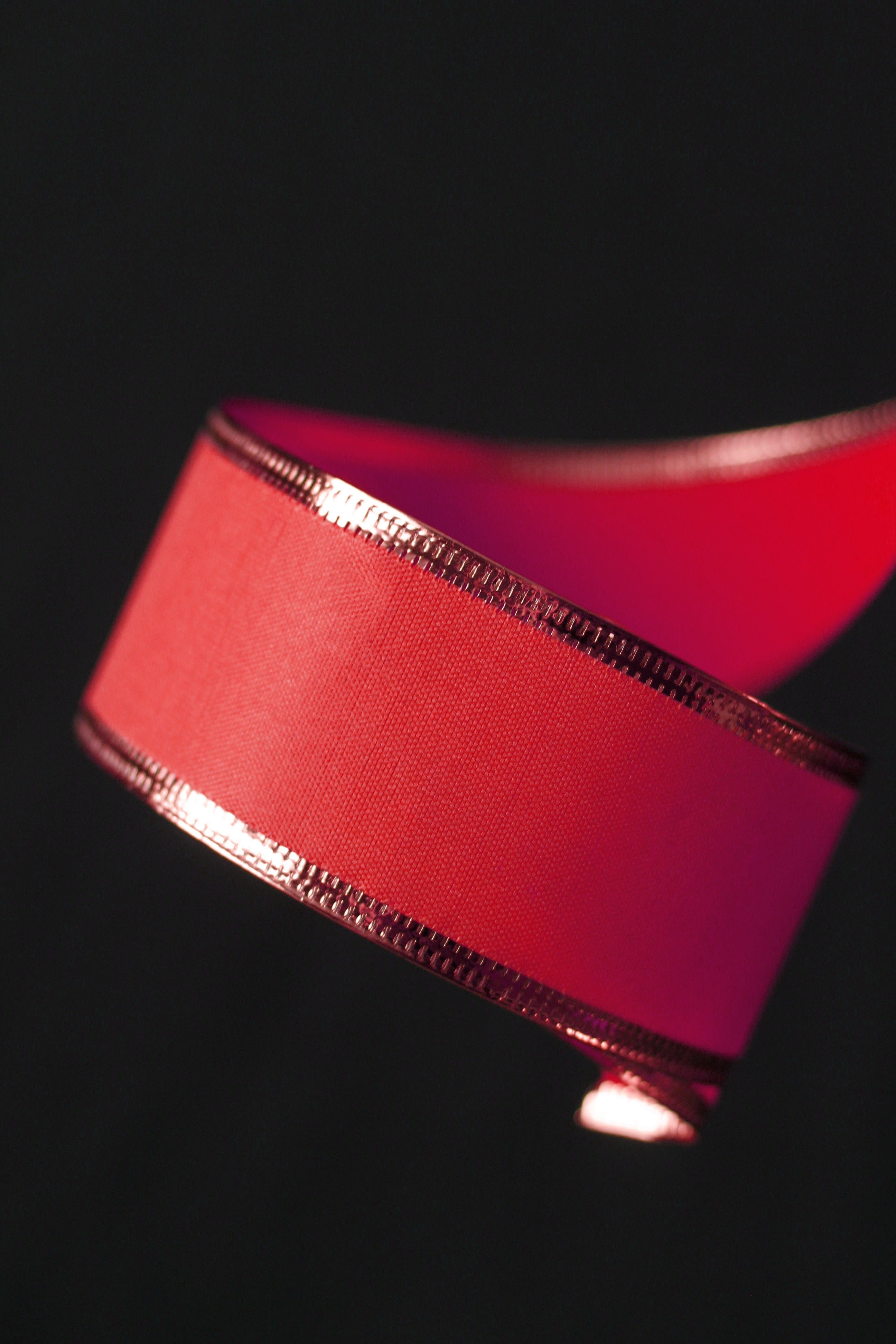 Elegant Red Ribbon with Metallic Edge on Black · Free Stock Photo
